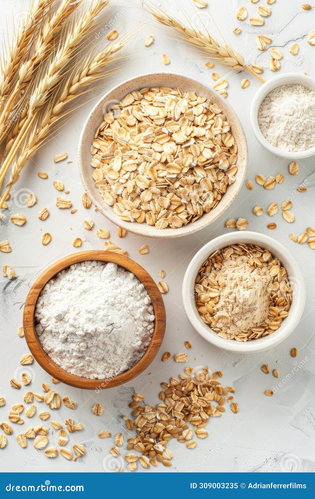 Bowls of Oat Flakes and Flour with Wheat Stalks on a Light Surface ...