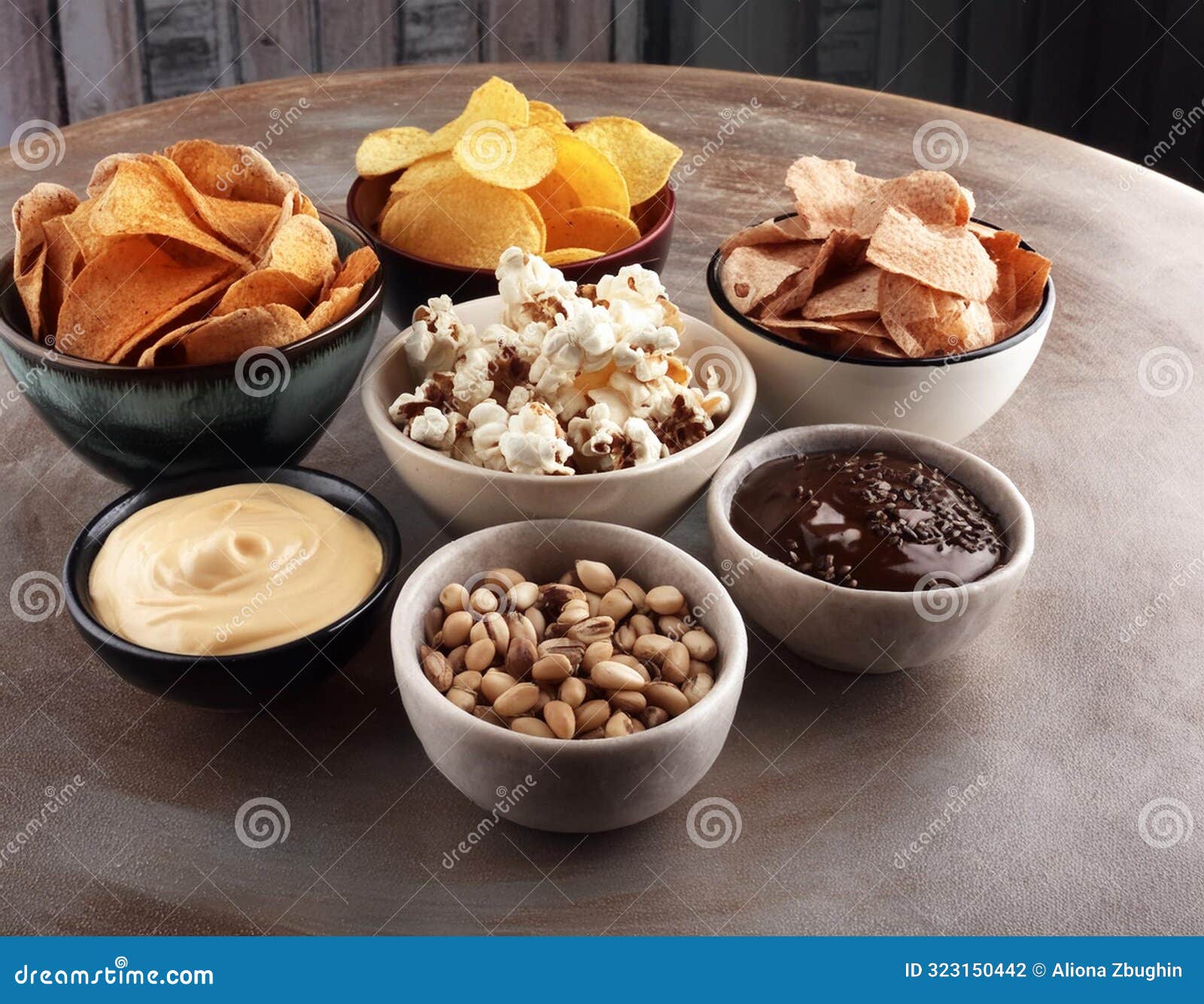 Bowls of Popcorn, Chips, Nuts, and a Dip on a Coffee Table Stock ...
