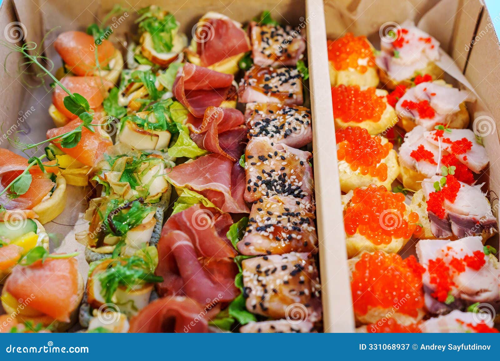 A Box with an Assortment of Meat and Fish Appetizers for the Buffet ...