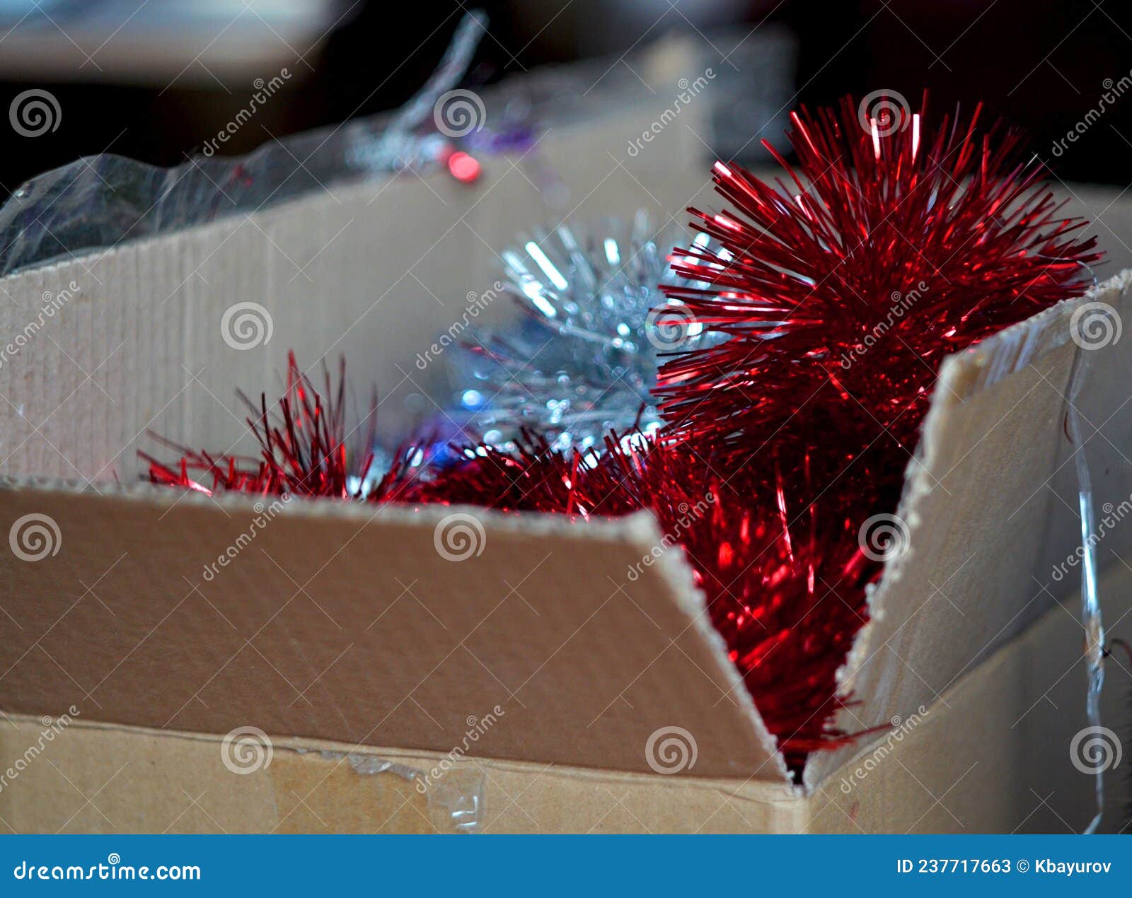 A Box with Christmas Tinsel for Decoration, an Open Box with ...