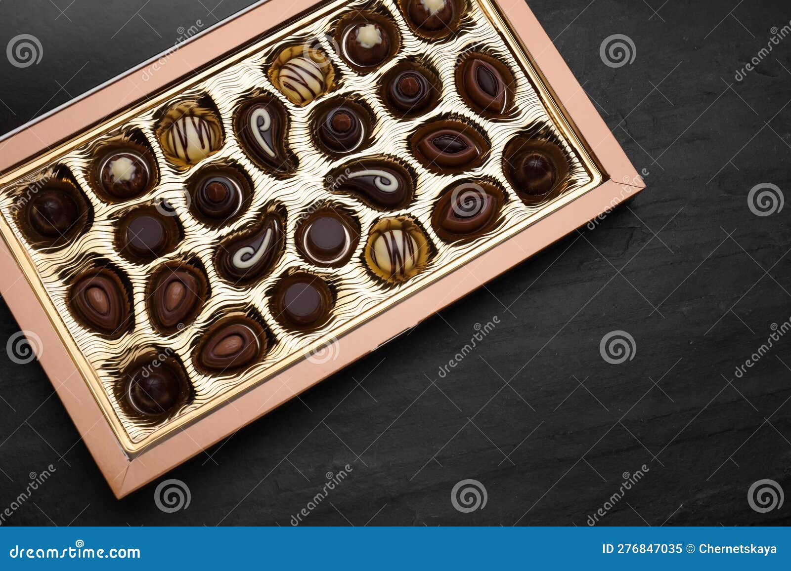 Box of Delicious Chocolate Candies on Black Table, Top View. Space for ...