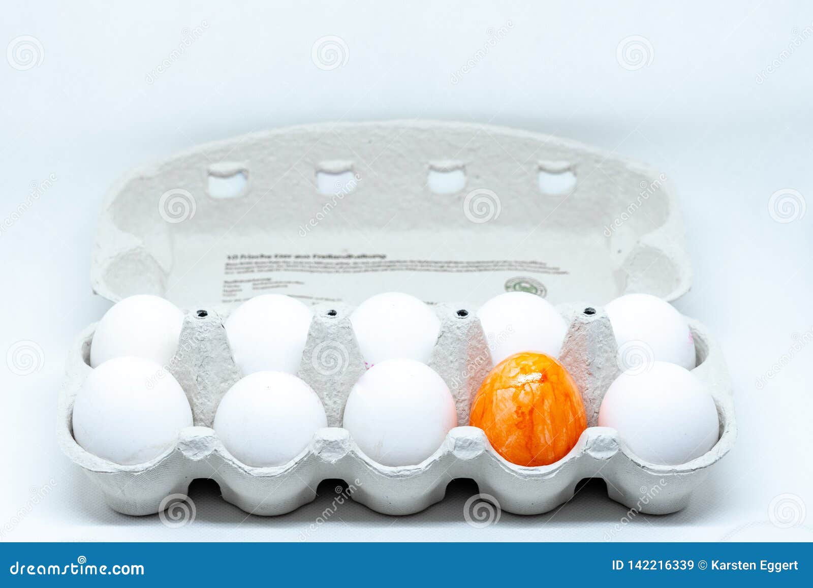 An Egg Box Filled with White Hen Eggs and an Orange Egg for Easter ...