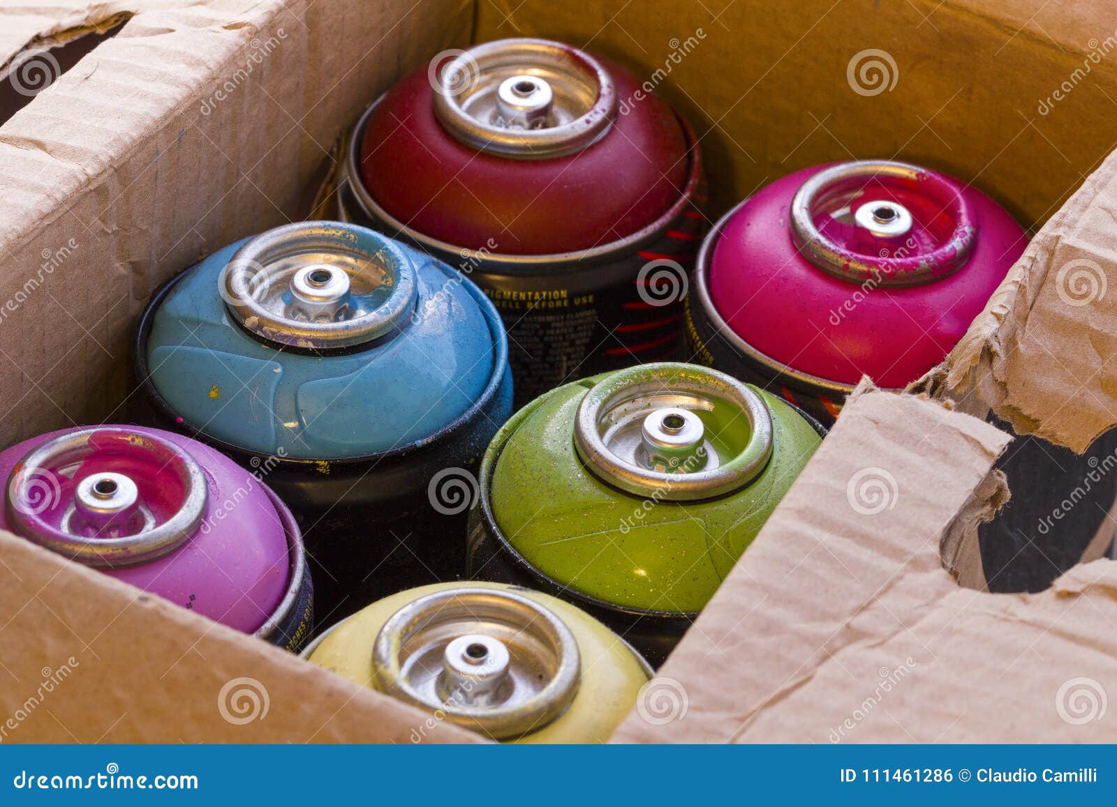Spray cans on paper box stock photo. Image of horizontal - 111461286