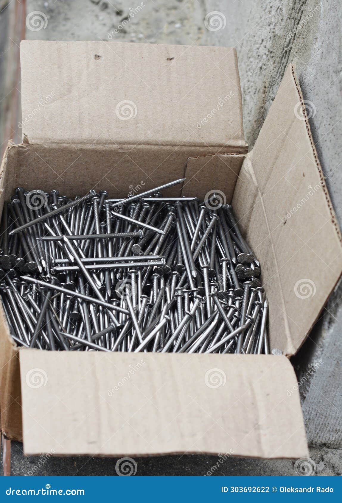 A Box Full of Long Metal Building Nails for a House Construction Stock ...