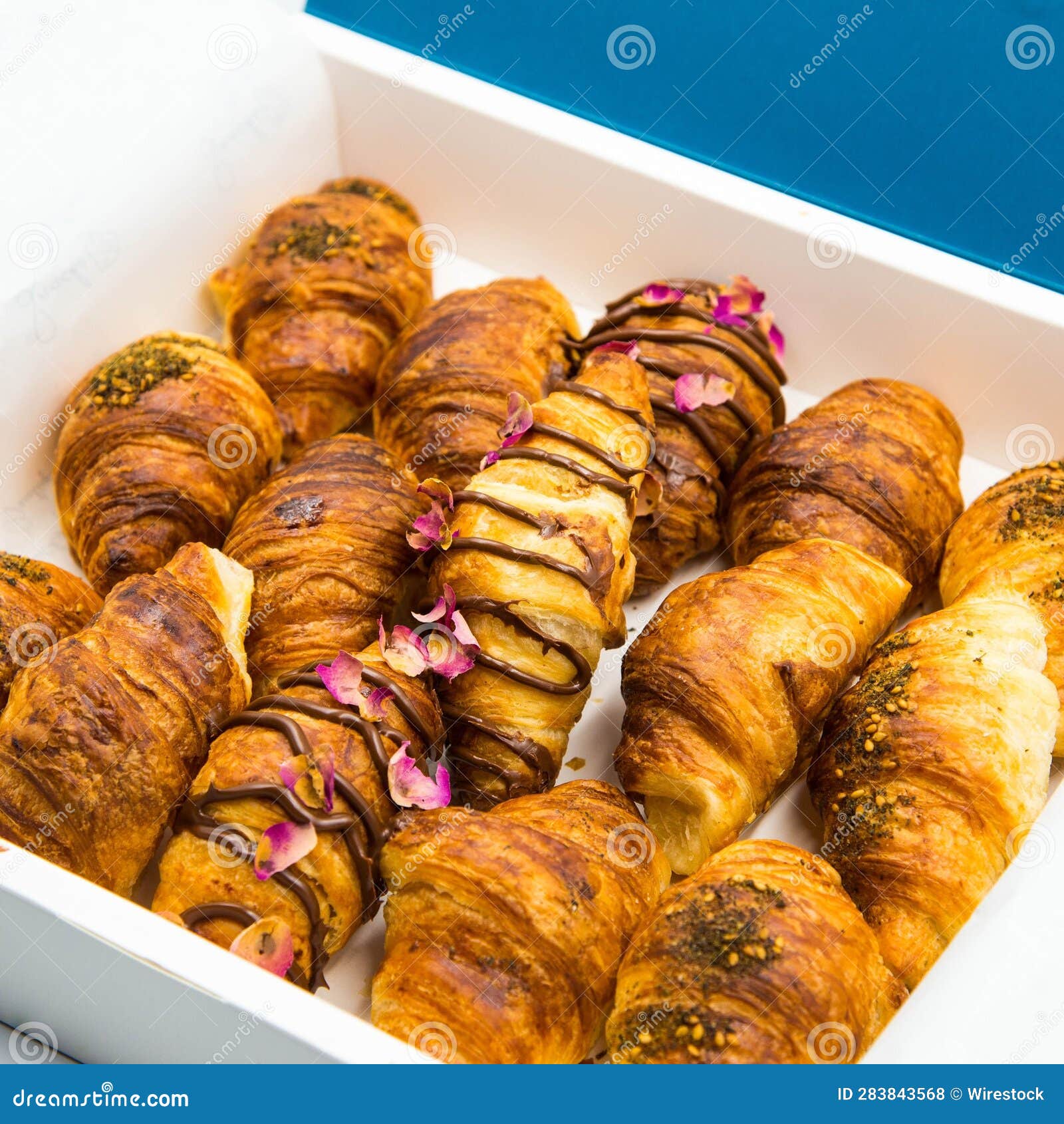 A Box that Has Many Different Type of Pastries Inside of it Stock Photo ...