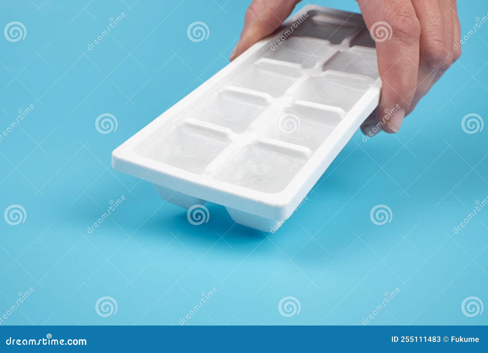 Box with Ice Cubes in Hand on a Blue Background Stock Image - Image of ...