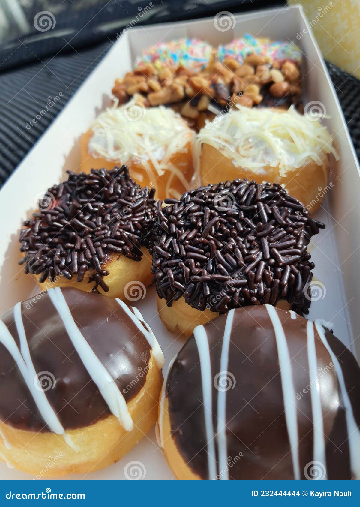 A Box of Small Donuts with Various Toppings Stock Photo - Image of ...