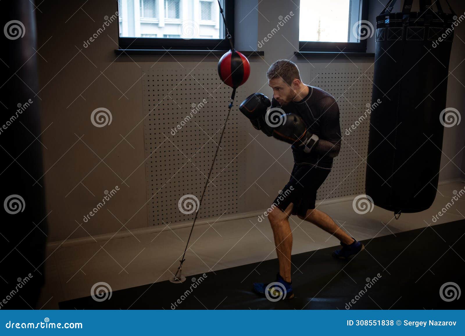 Boxer Practicing Coordination and Punches on Floor-to-ceiling Bag in ...