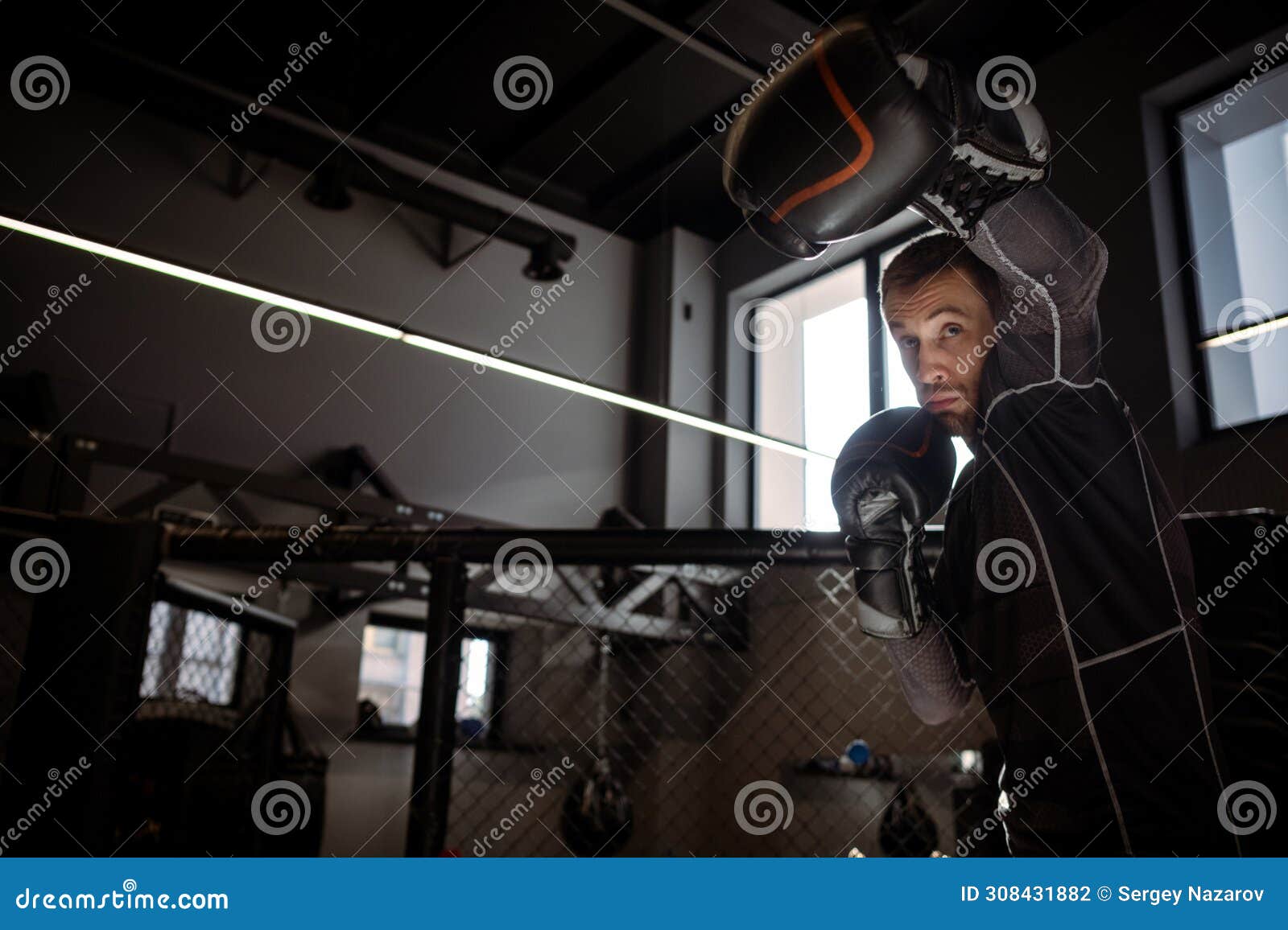 Boxer Throwing Powerful Left Hook during Shadowboxing in Gym Stock ...