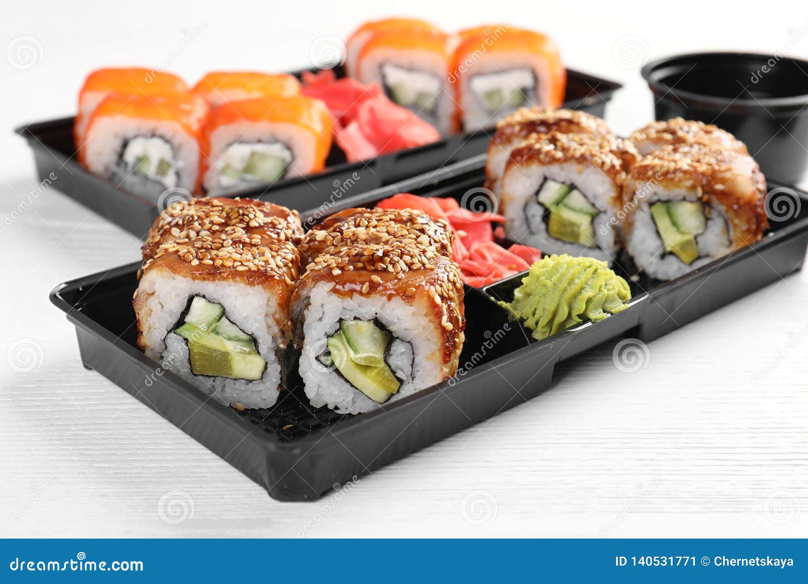 Boxes with Tasty Sushi Rolls on White Table. Stock Image - Image of ...