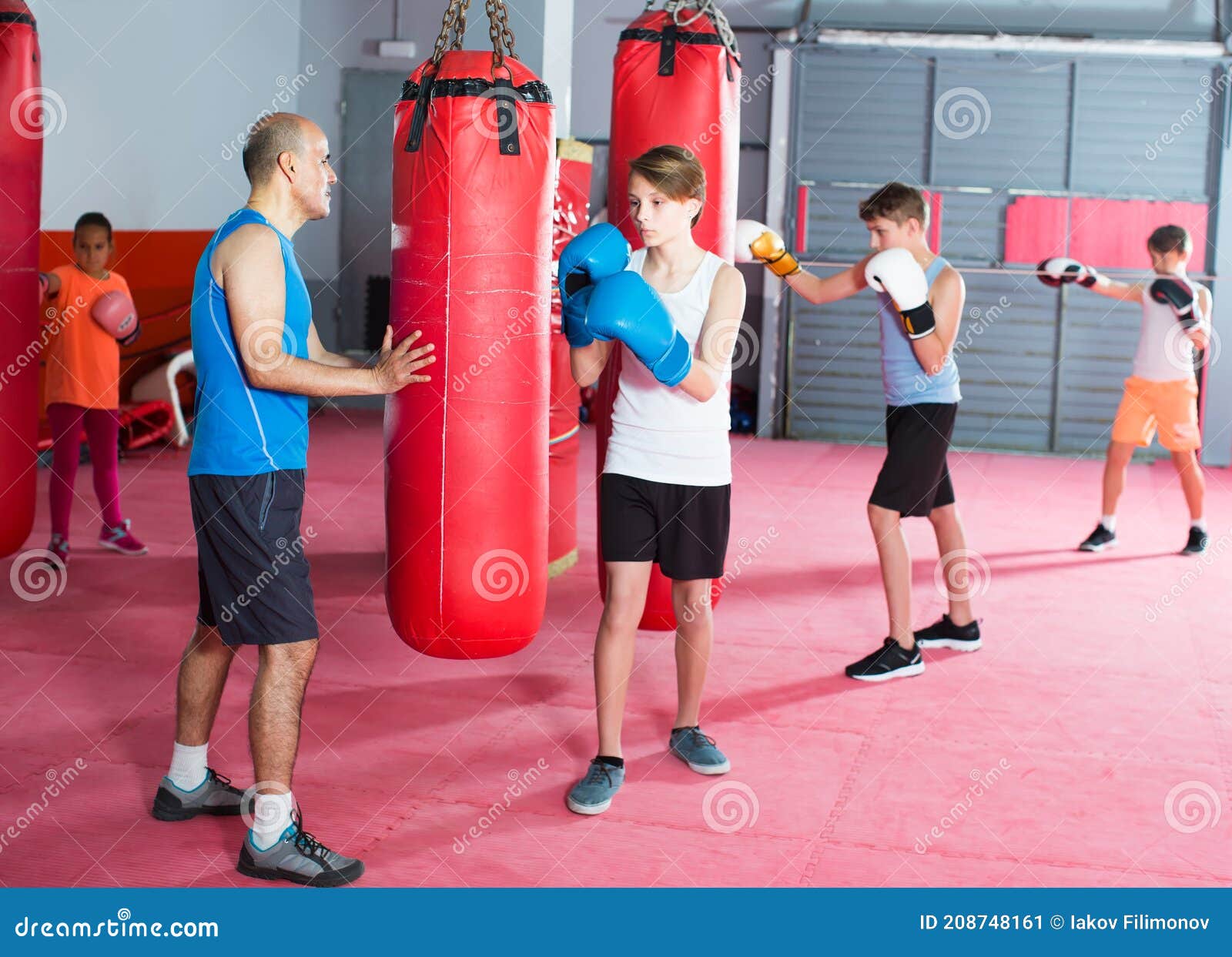 Boxing Instructor Helps Children Learn Techniques of Strikes Stock ...