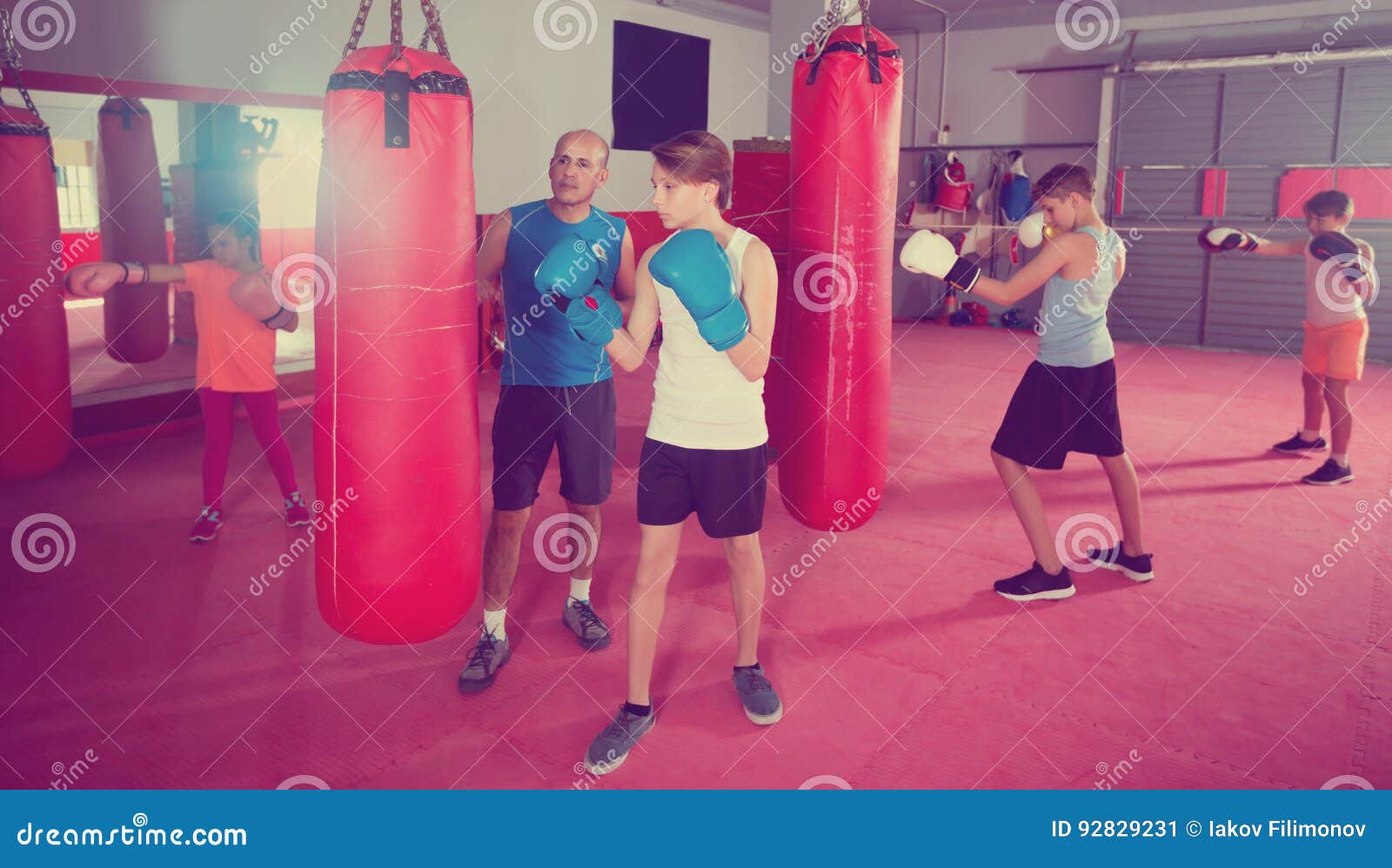 Boxing Instructor and Young Children Practicing Blows Stock Image ...