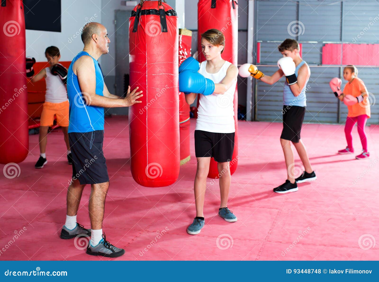 Boxing Instructor and Young Children Practicing Blows Stock Photo ...