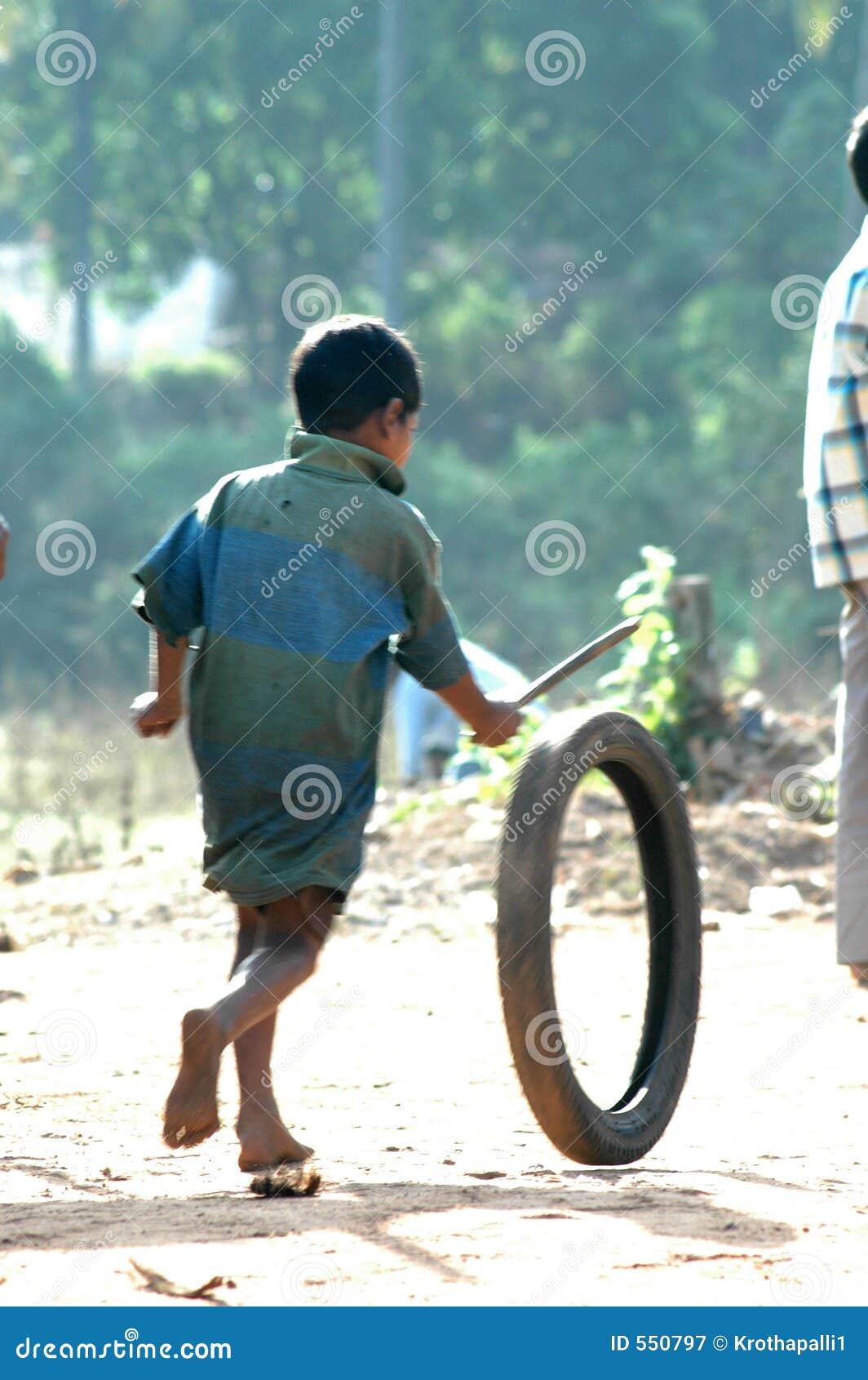 Boy stock image. Image of children, play, village, tire - 550797