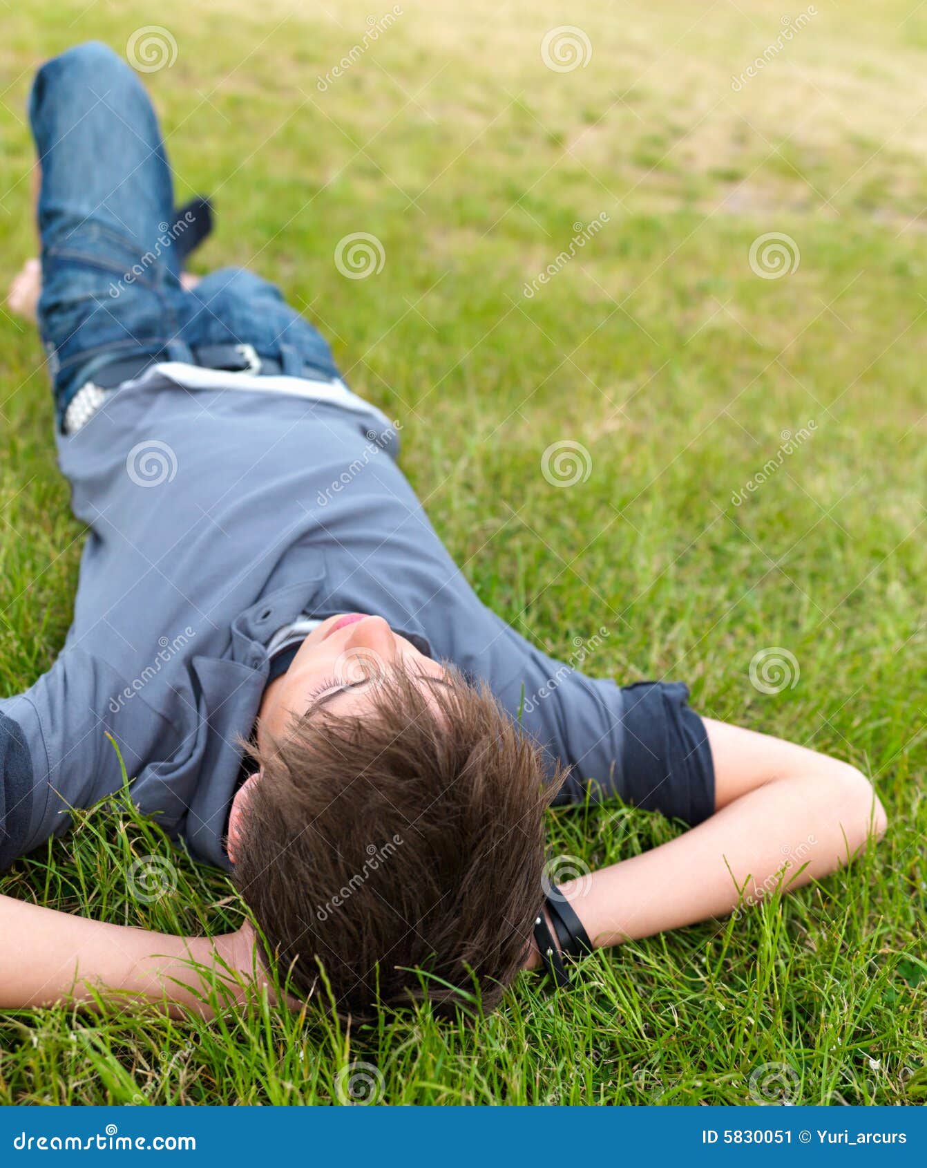 Boy Alone Lying on Green Grass Stock Image - Image of children, leisure ...