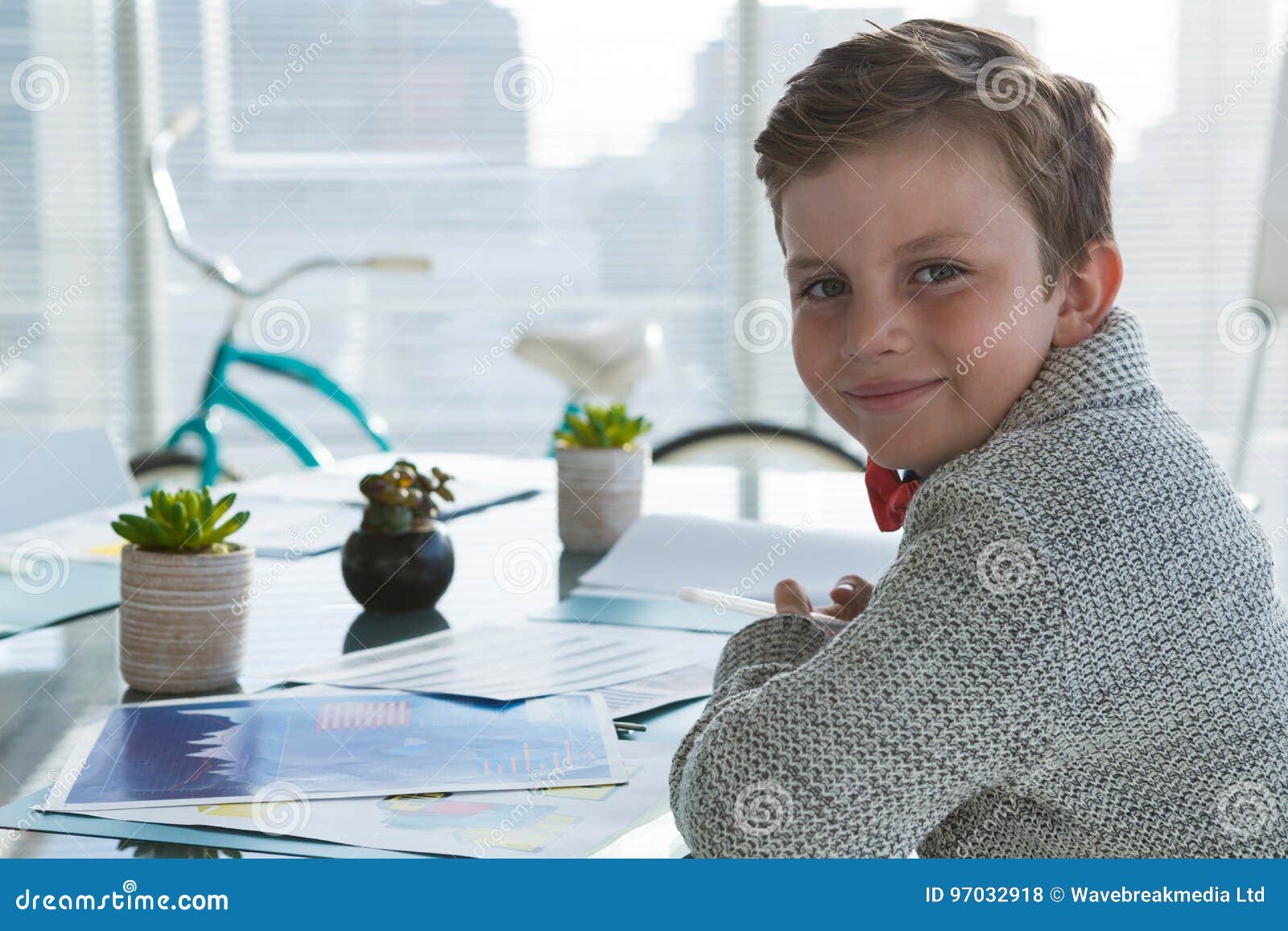 Boy As Business Executive Smiling while Sitting in Office Stock Photo ...