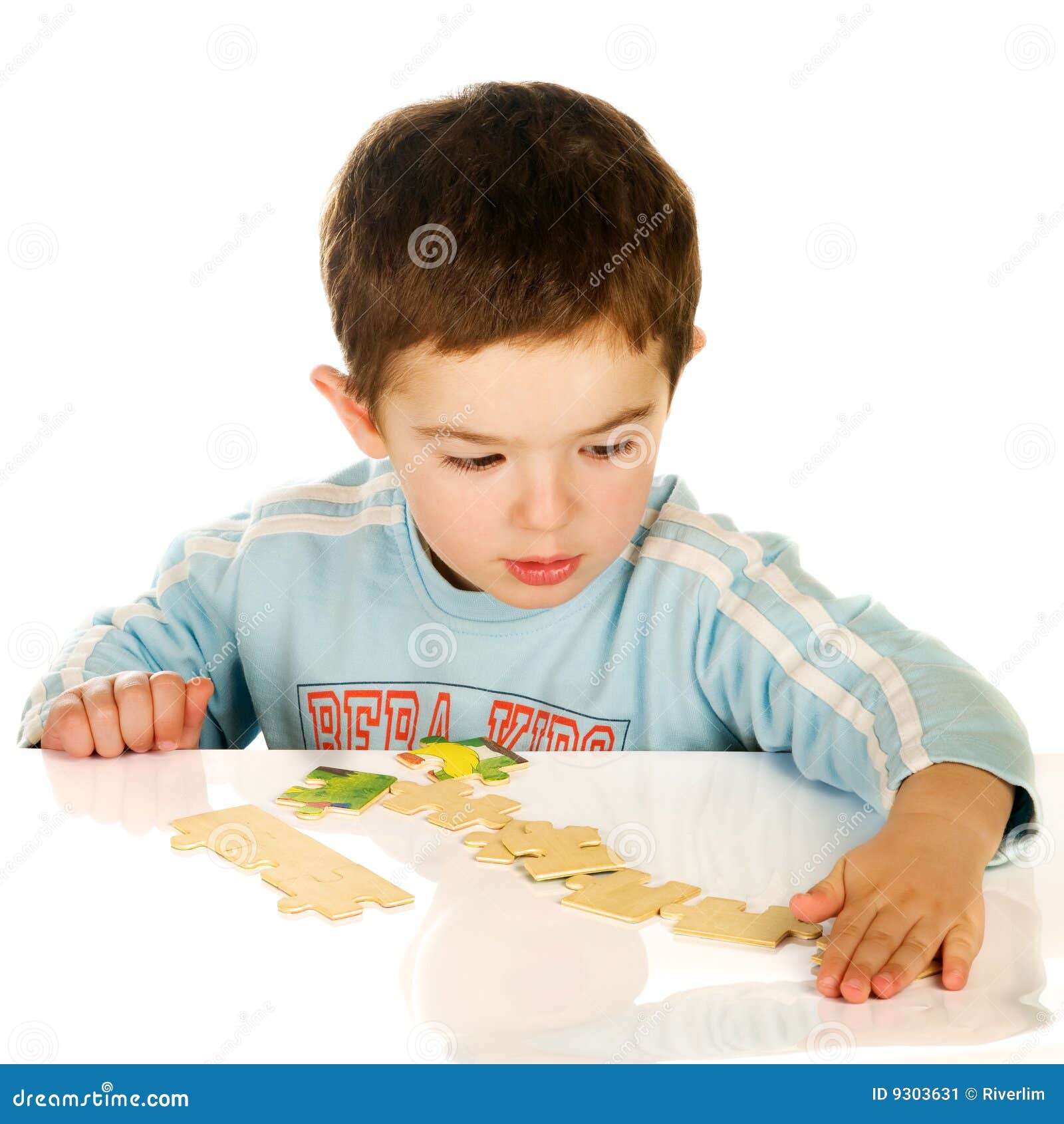 Boy assembling puzzle stock image. Image of difficulty - 9303631