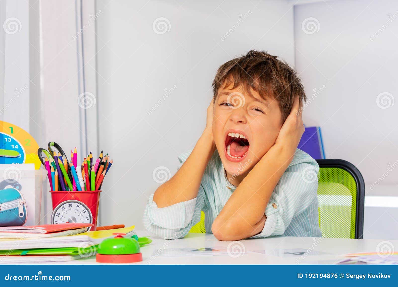 Boy with Autism at the Table Close Ears and Scream Stock Photo - Image ...