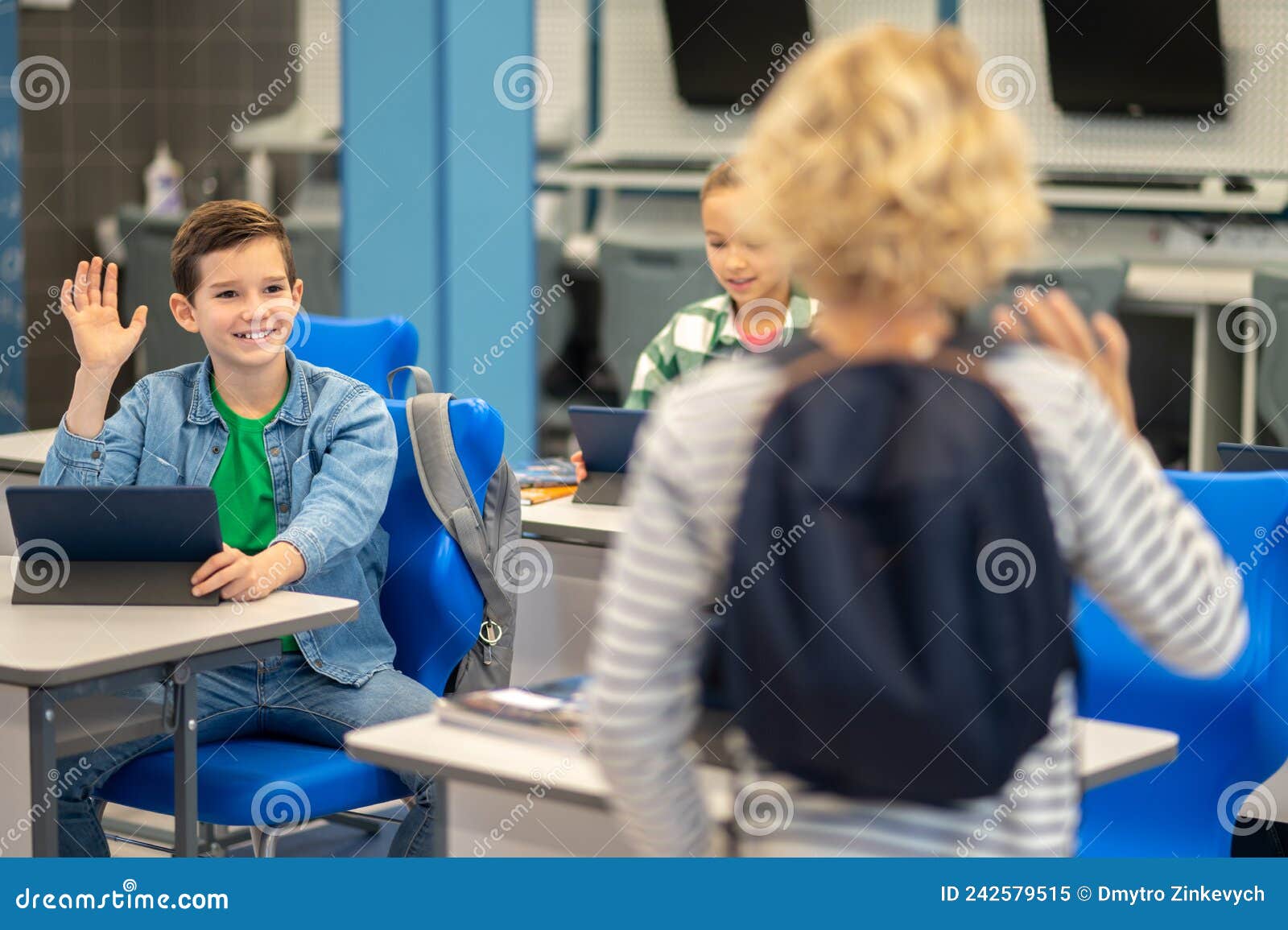 Boy with Back To Camera Greeting Classmates Stock Image - Image of ...