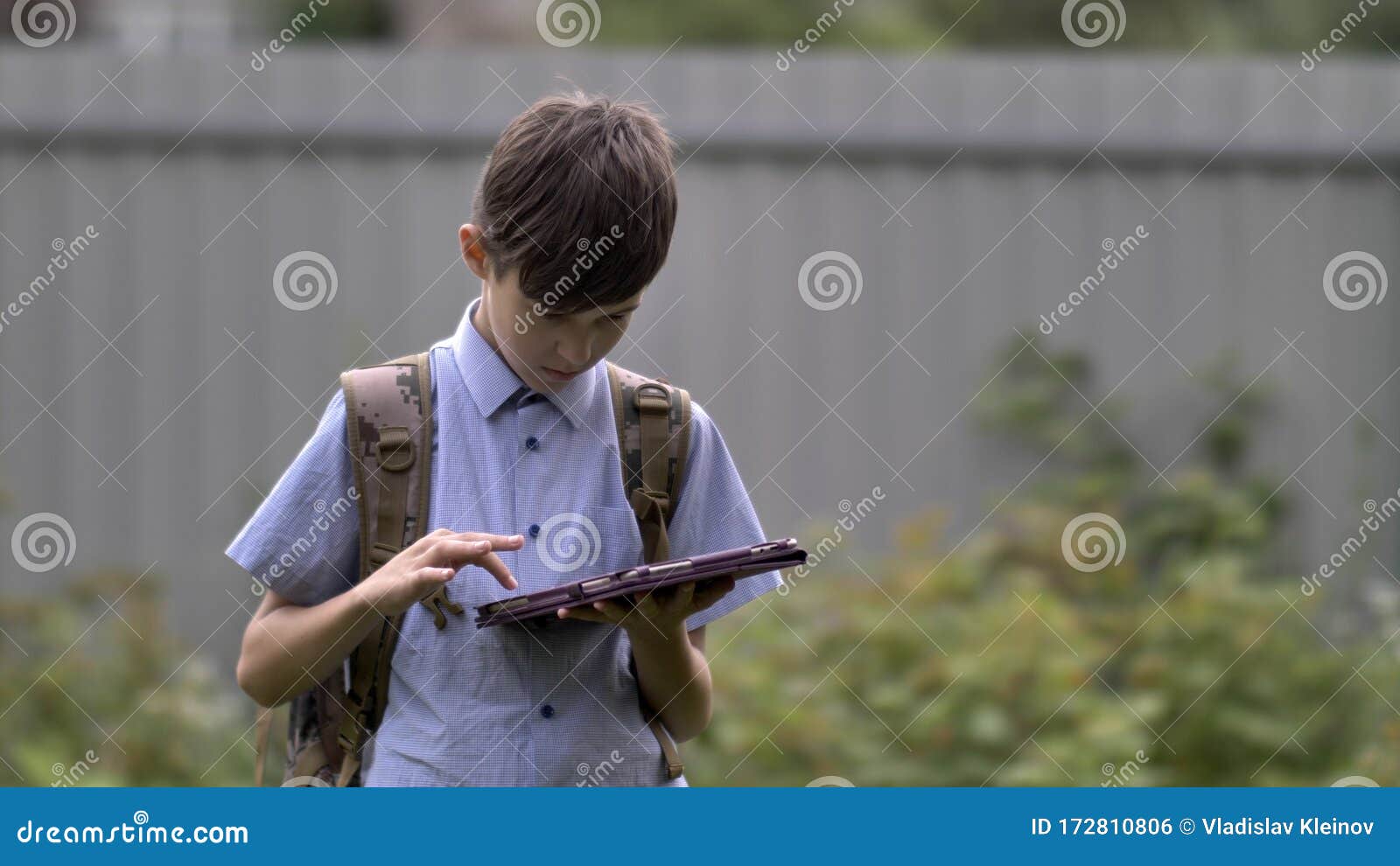 Boy with Backpack Uses Tablet Outdoors, Go To School Stock Photo ...