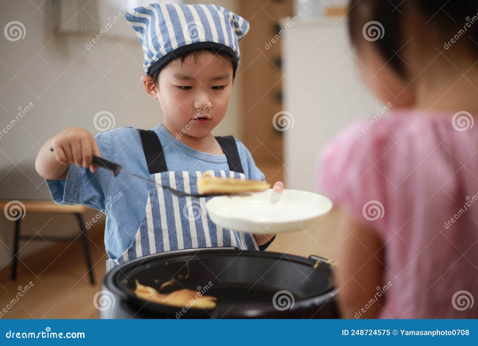Boy baking pancakes stock image. Image of aprons, family - 248724575