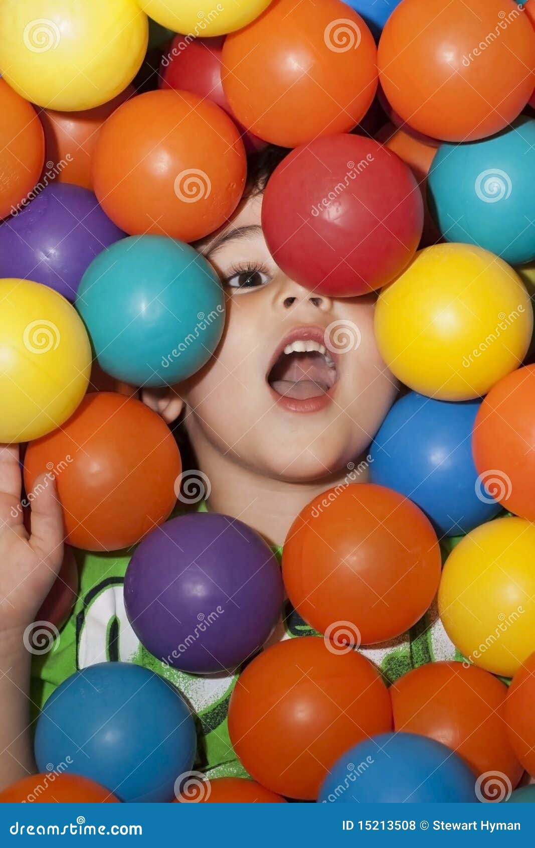 Boy in a ball pit stock photo. Image of color, buried - 15213508