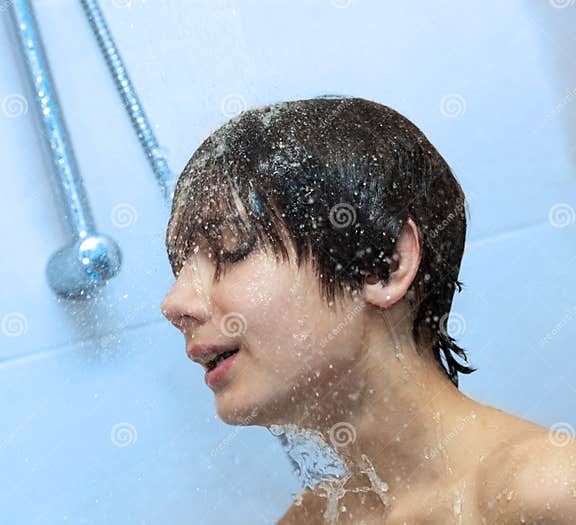 Boy bathing under a shower stock image. Image of toned - 14869765