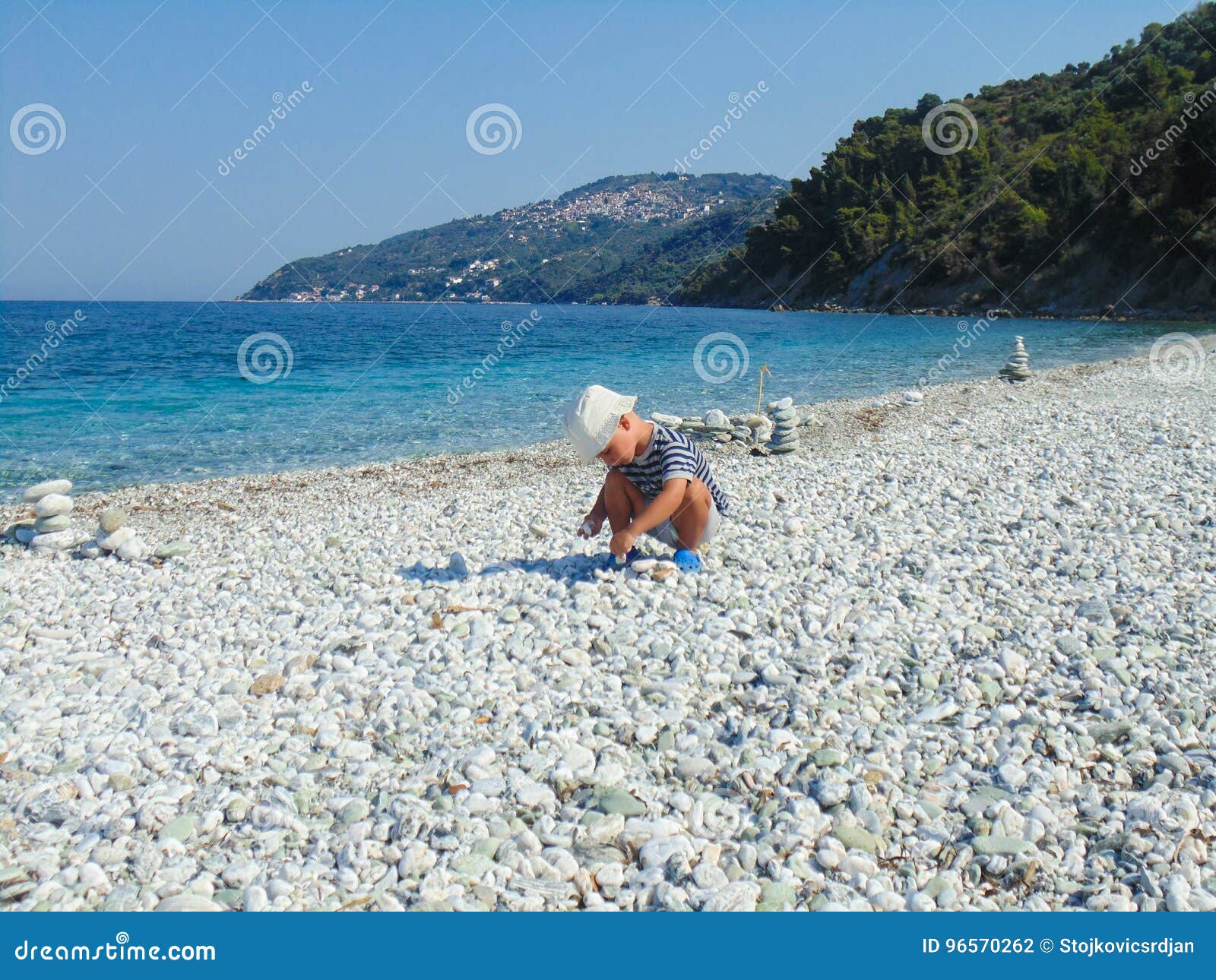 Boy on the beach stock photo. Image of rocks, little - 96570262