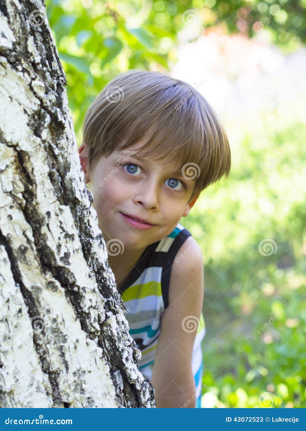 Boy behind the tree stock image. Image of friends, face - 43072523