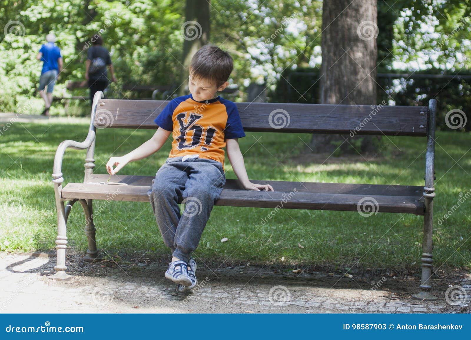 Boy on bench in park. stock image. Image of beauty, closeup - 98587903