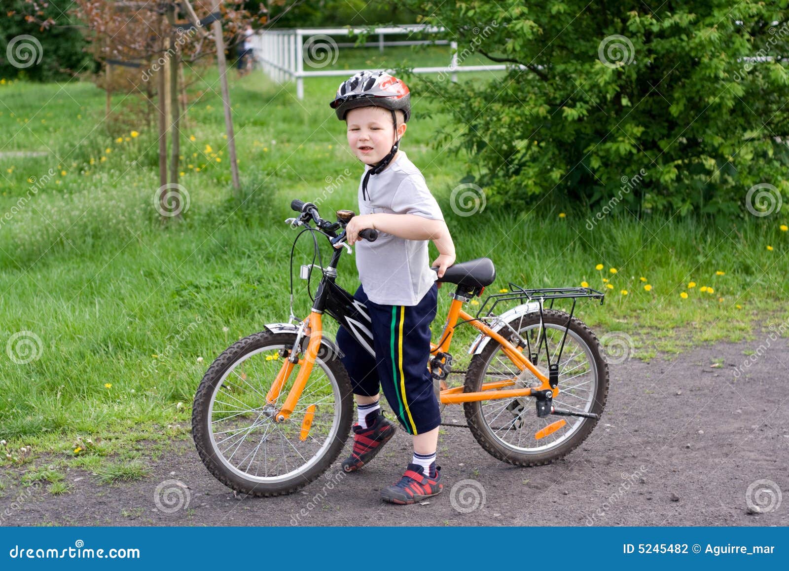 Boy on bicycle stock photo. Image of helmet, face, green - 5245482