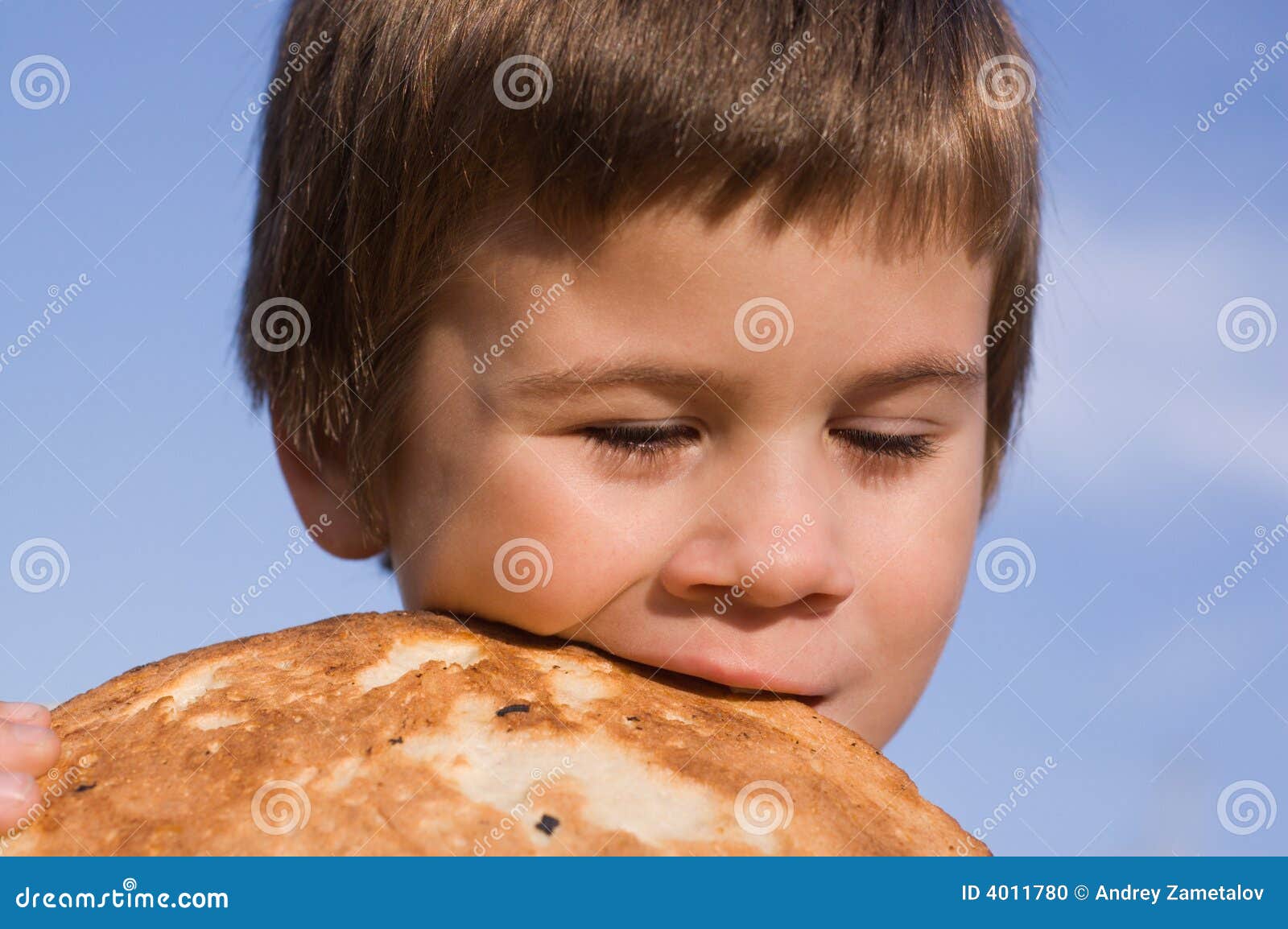 Boy bites bread stock photo. Image of bread, food, appetite - 4011780