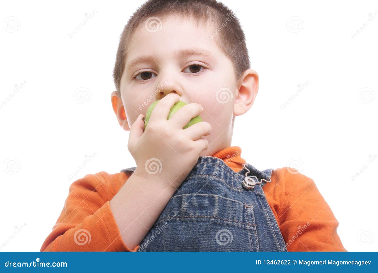 Boy biting apple stock photo. Image of orange, child - 13462622