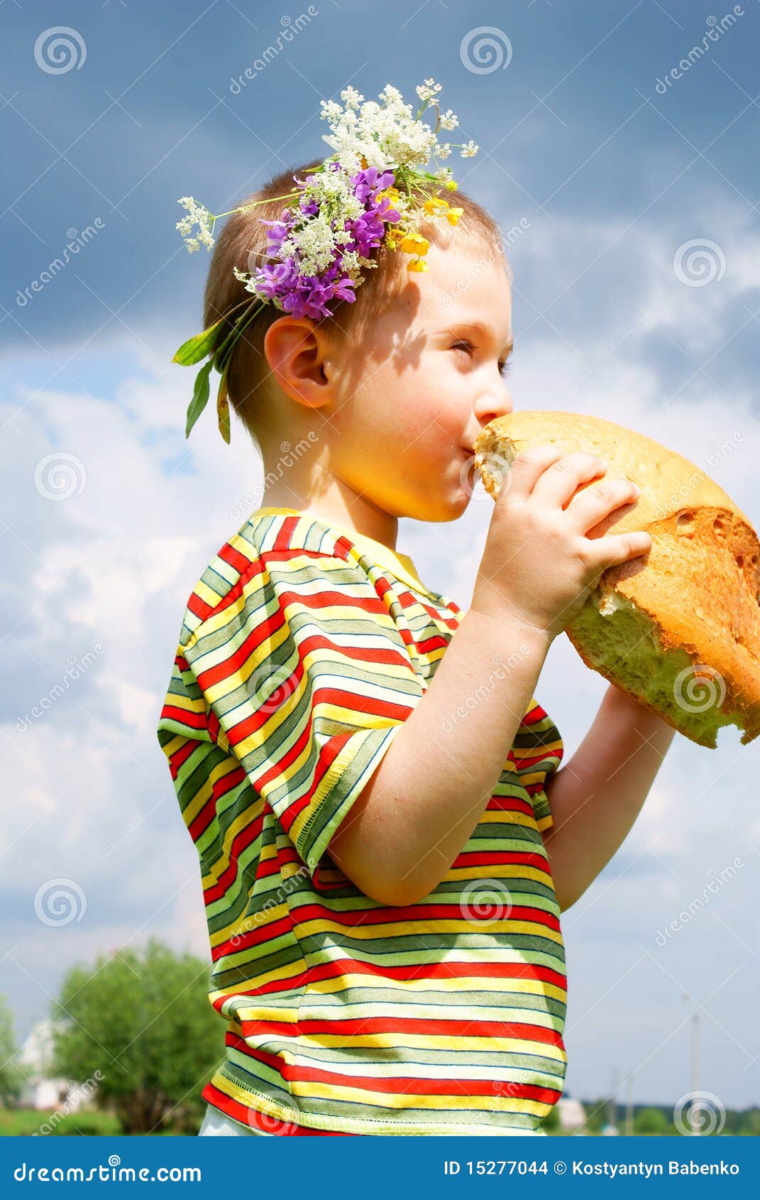 Boy biting a loaf of bread stock photo. Image of health - 15277044