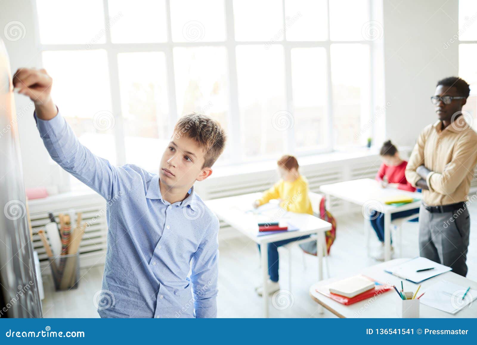 Boy by blackboard stock image. Image of school, blackboard - 136541541