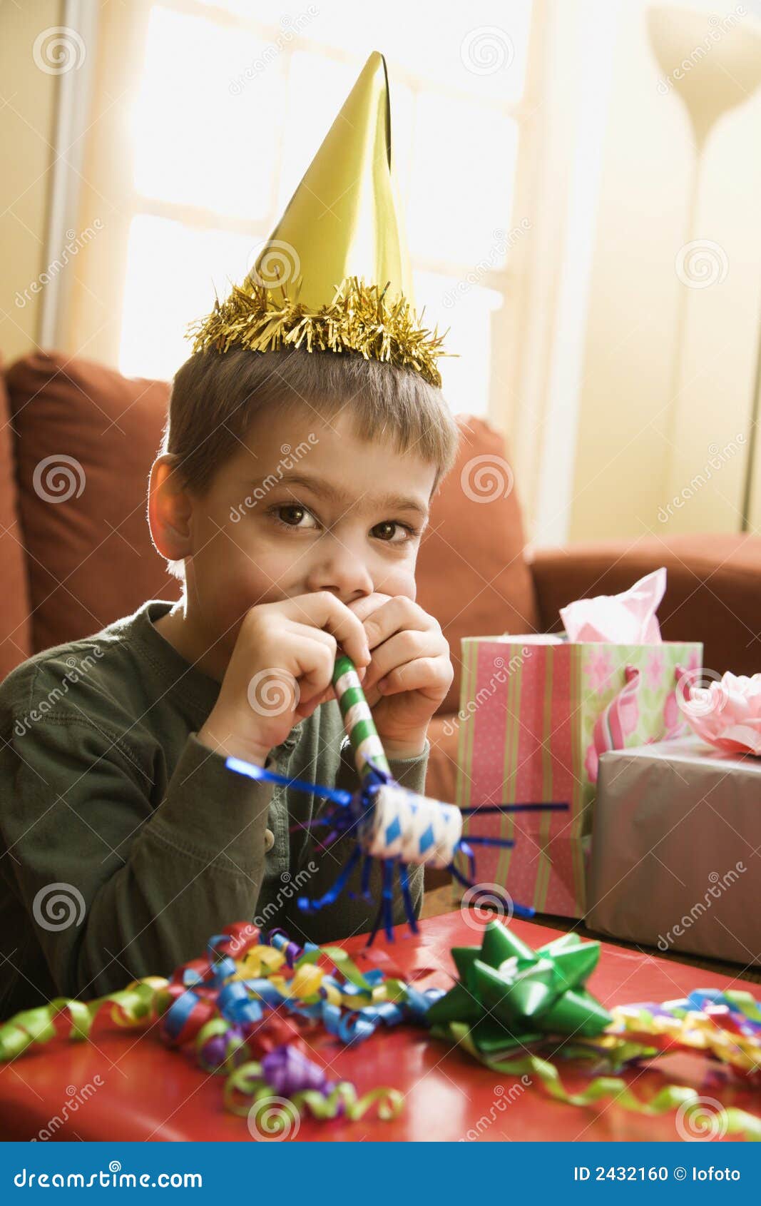 Boy blowing noisemaker. stock photo. Image of colour, portrait - 2432160