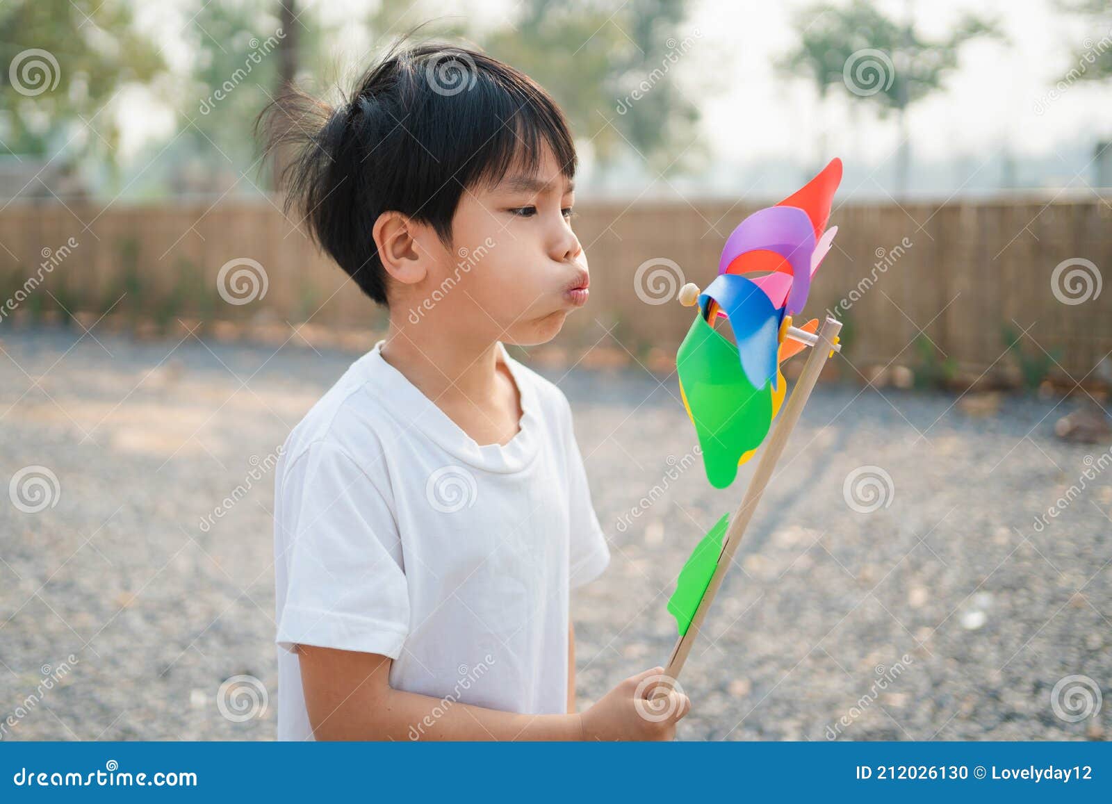 Boy Blowing a Toy Windmill in the Morning Stock Photo - Image of nature ... Boy Blowing a Toy Windmill in the Morning Stock Photo - Image of nature ...