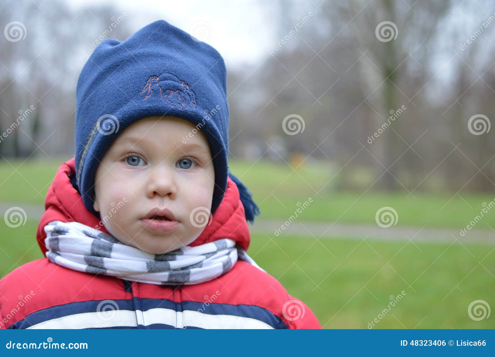 Boy in a blue cap stock photo. Image of trees, green - 48323406