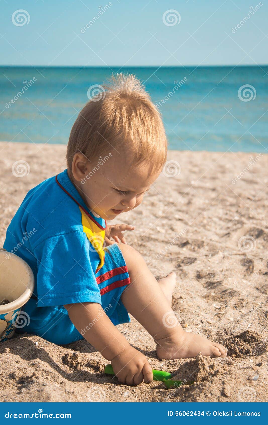 A Boy in a Blue Suit Played on the Beach Stock Photo - Image of waters ...
