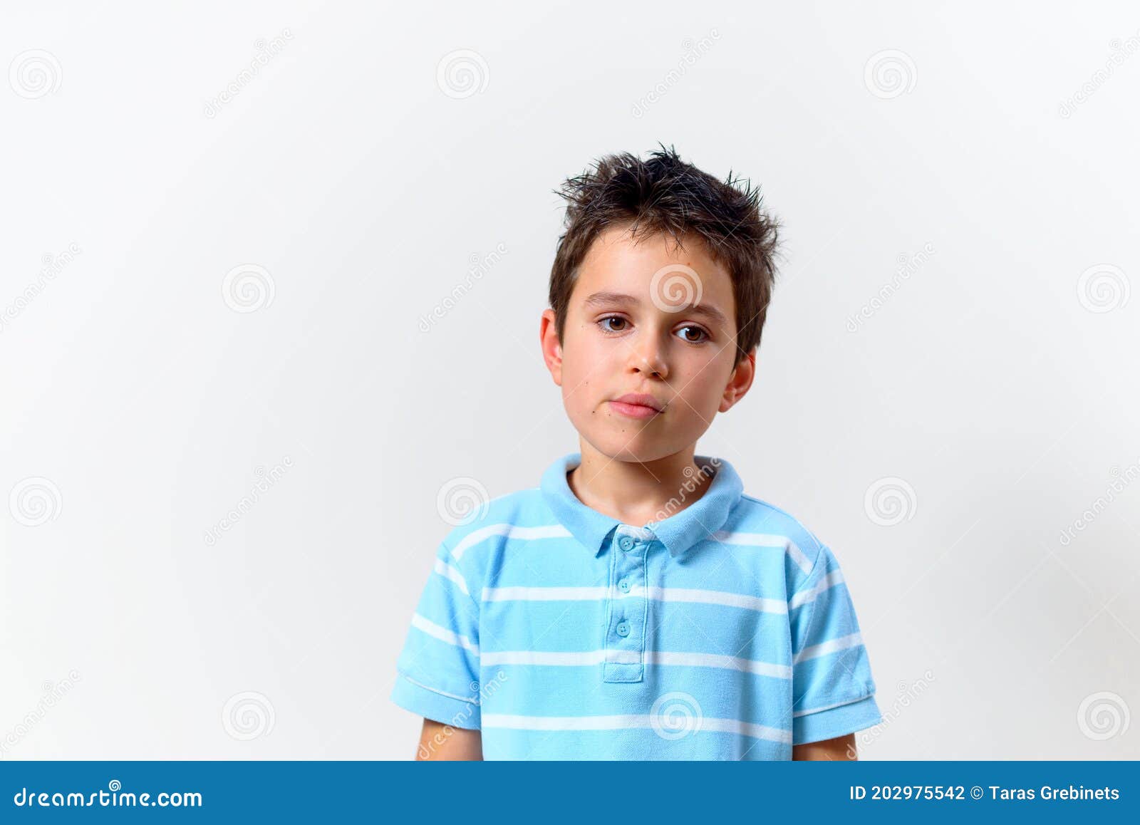A Boy in a Blue T-shirt with a Brooding Face Looks Somewhere from the ...