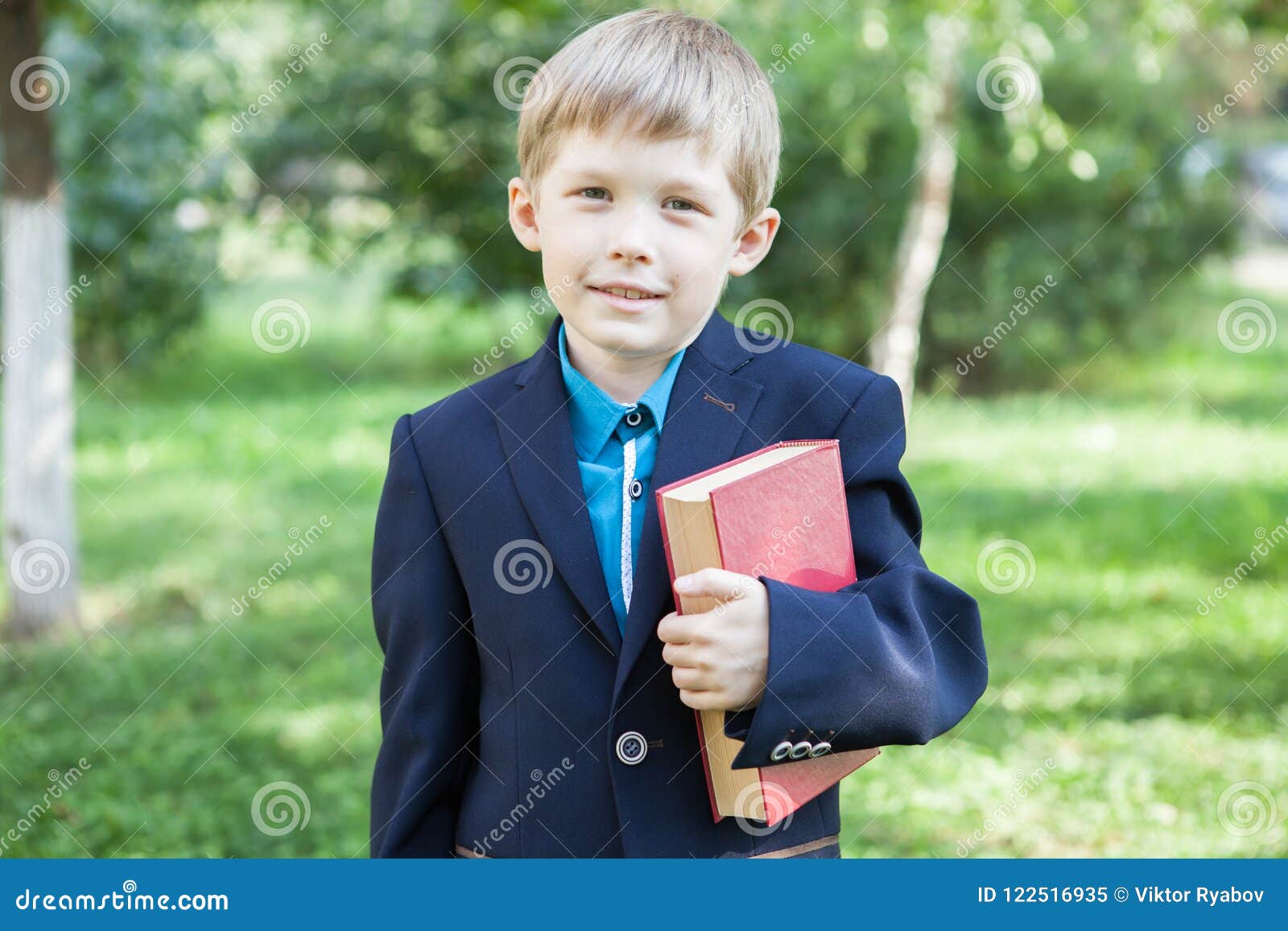 A Boy with a Book in His Hand. the Boy is Reading a Book in the Open ...