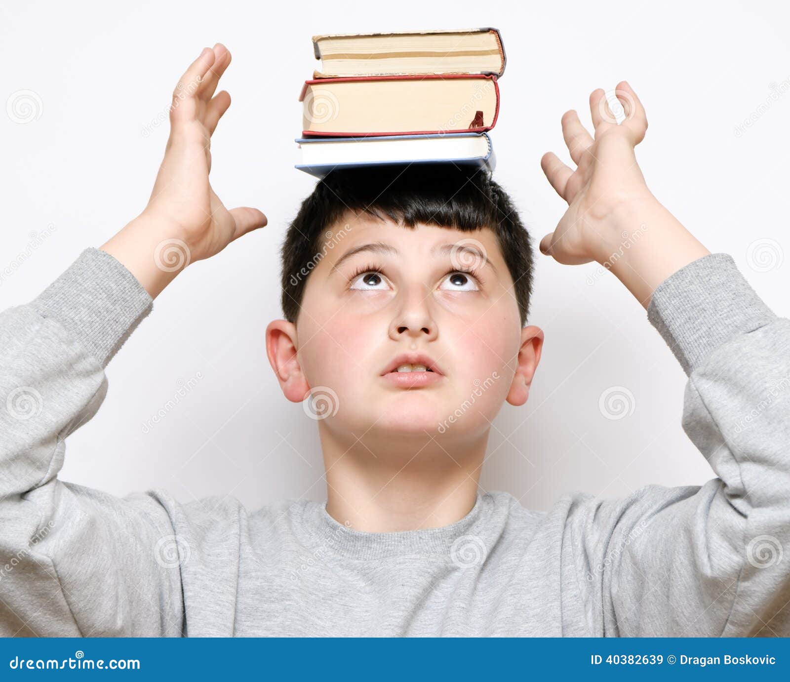 Boy with books on her head stock image. Image of expression - 40382639