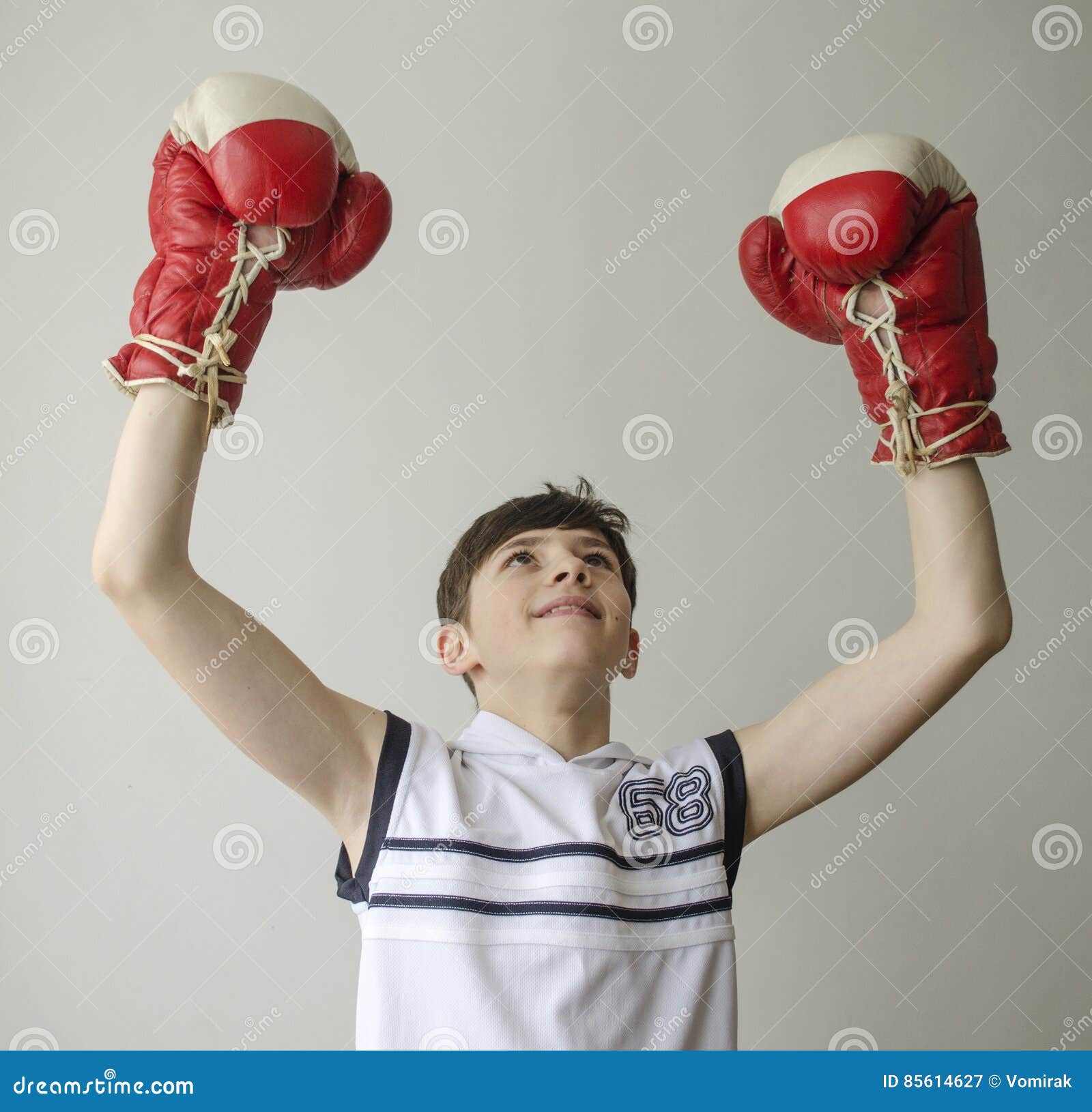 Boy in Boxing Gloves with Raised Hands in Victory Gesture Stock Image ...