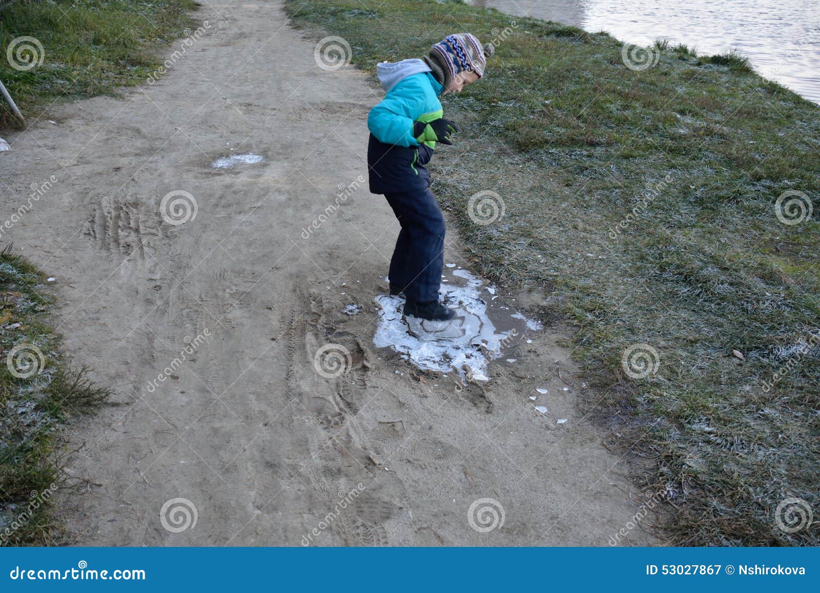 Boy breaks ice on puddles stock image. Image of cold - 53027867