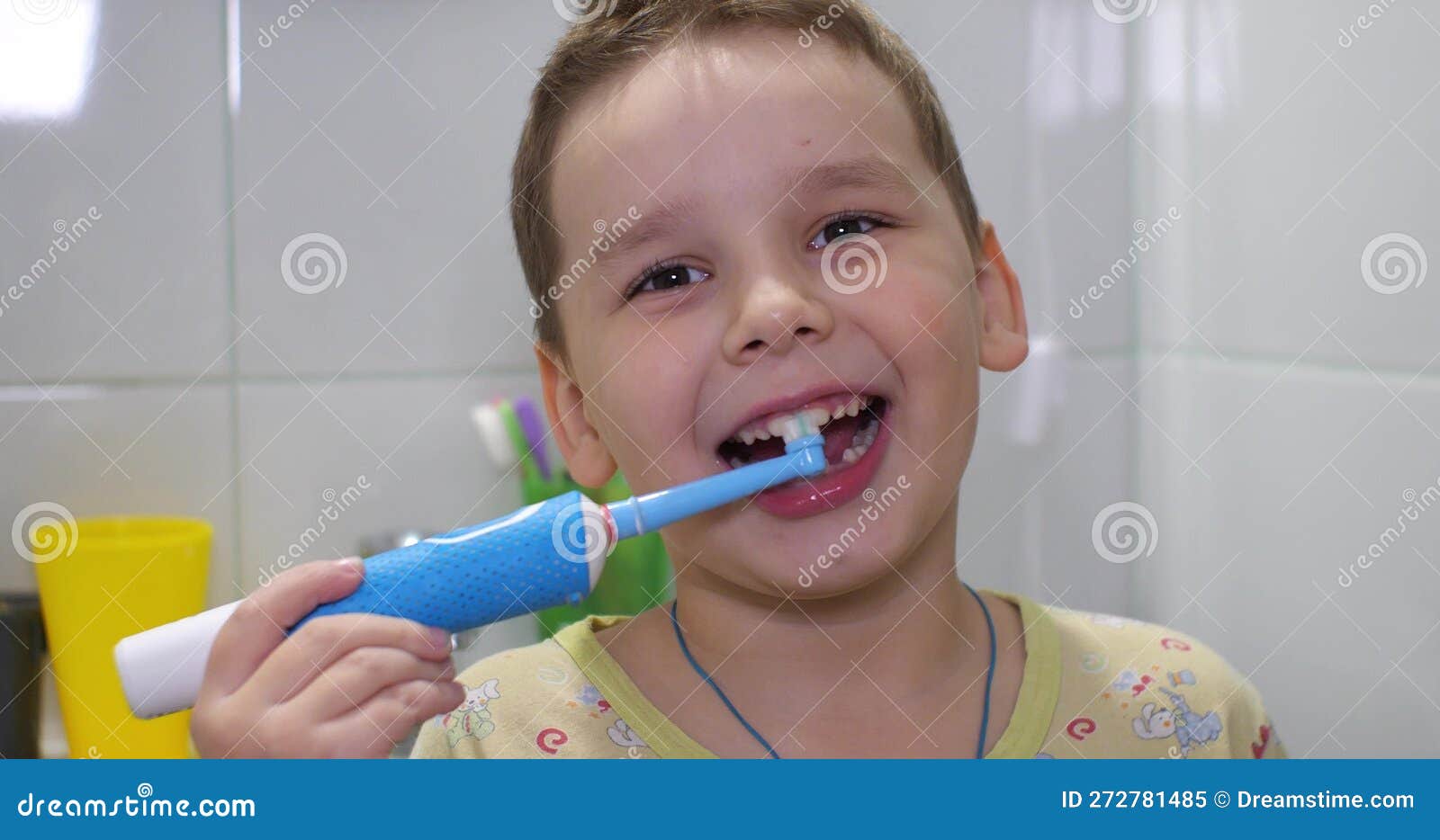 The Boy Brushes His Teeth before Going To Bed with an Electric ...
