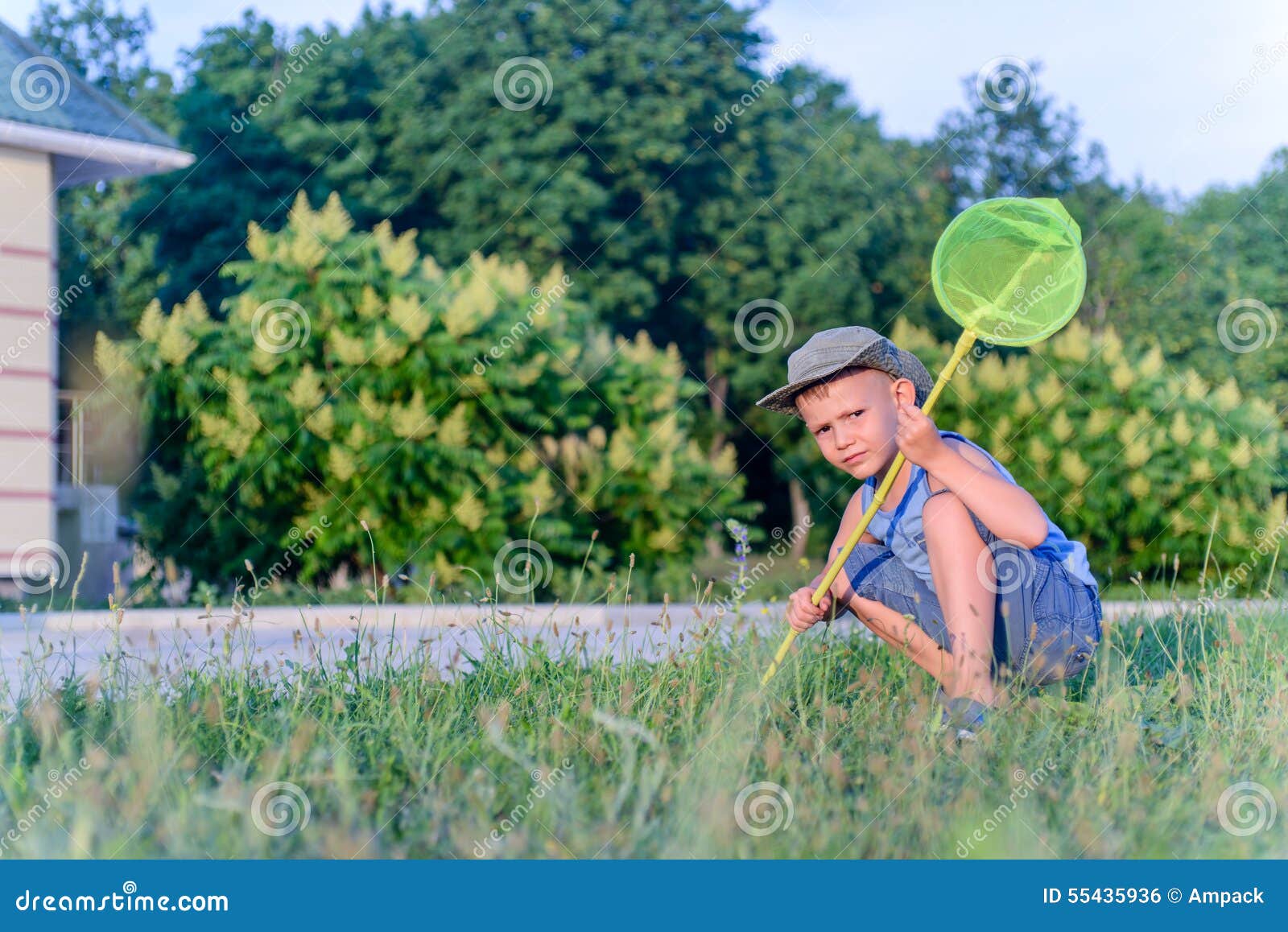 Boy with Bug Net Crouching in Long Grass on Lawn Stock Photo - Image of ...