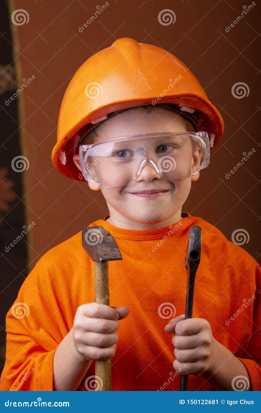 Boy in builder`s clothes stock image. Image of equipment - 150122681