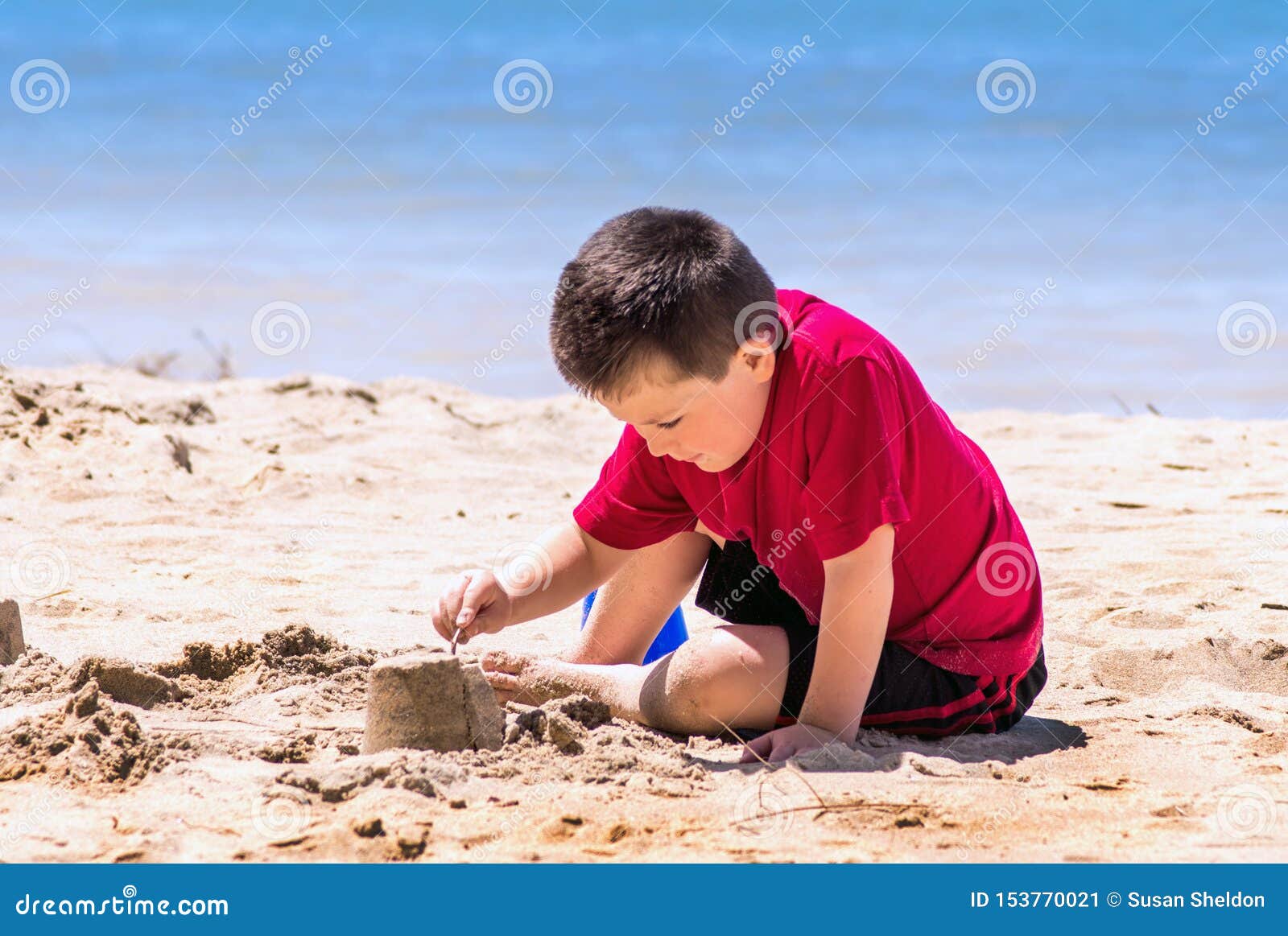 Boy Building a Sand Castle on the Beach Stock Image - Image of playing ...