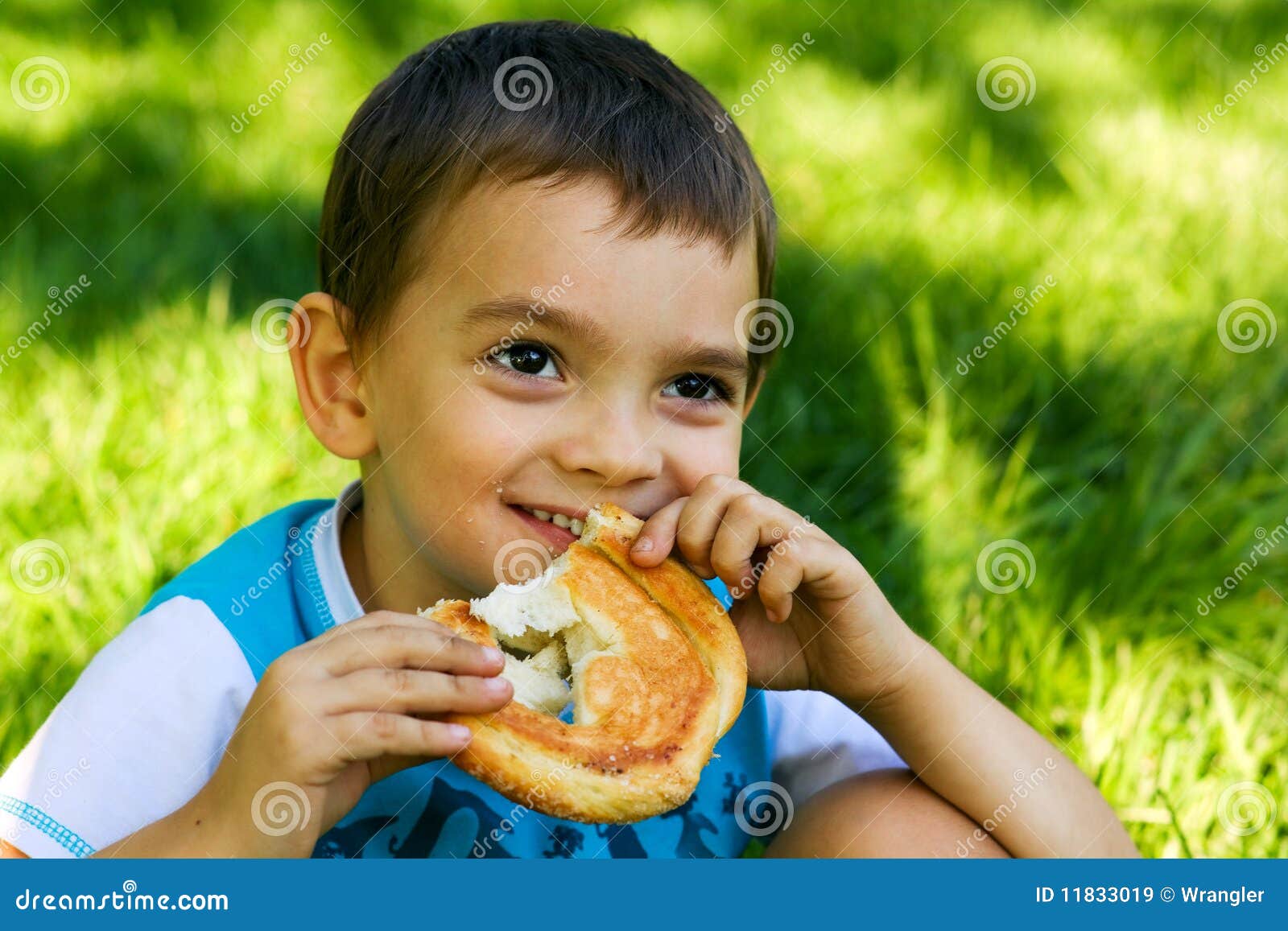 Little Boy Eating a Bun on Nature Stock Image - Image of hungry ...