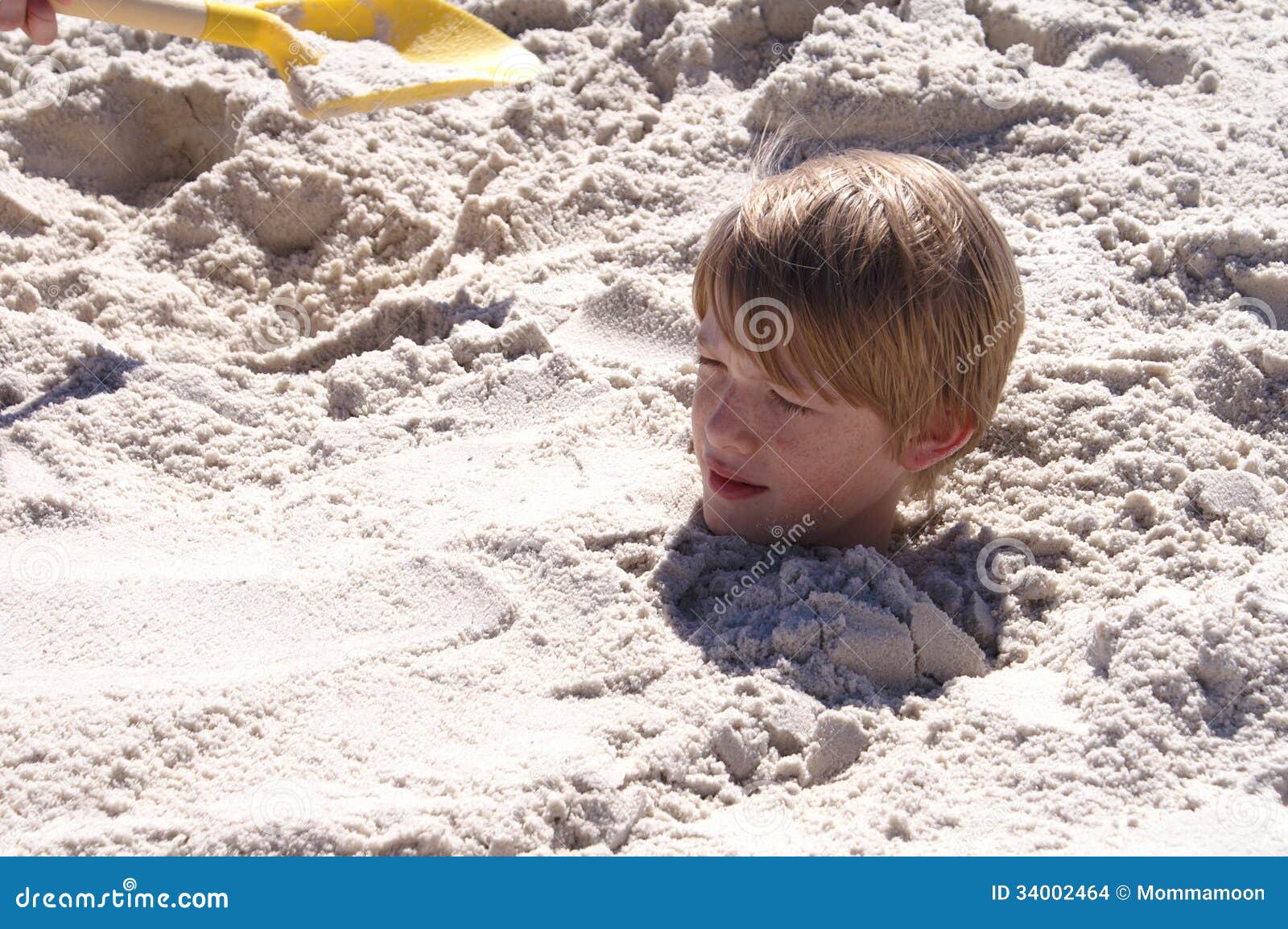 Boy Buried in Sand stock photo. Image of happy, blond - 34002464